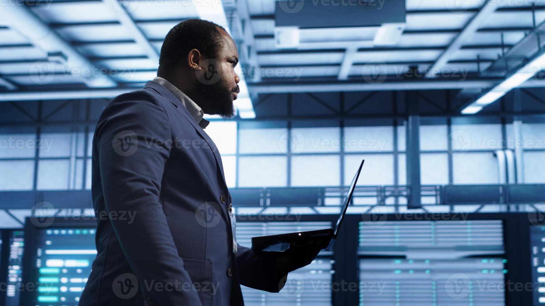 Admin Doing Yearly Checkup Using Notebook To Prolong Data Center Electronics Life Span And Avoid