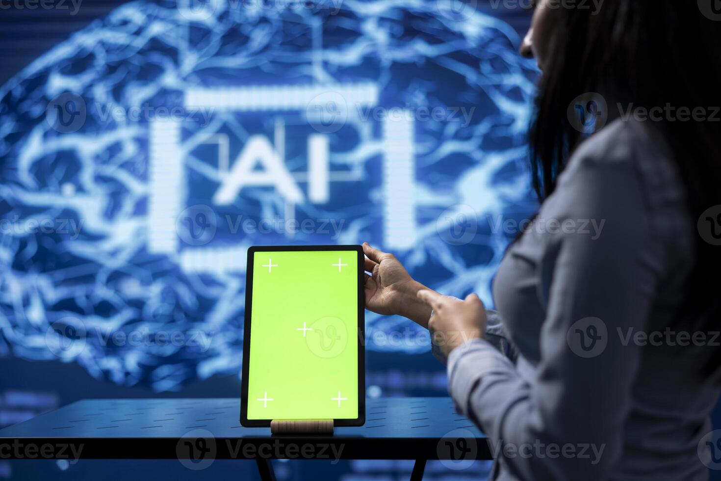 Startup coworkers brainstorming ways to use AI on chroma key tablet to improve data driven ...