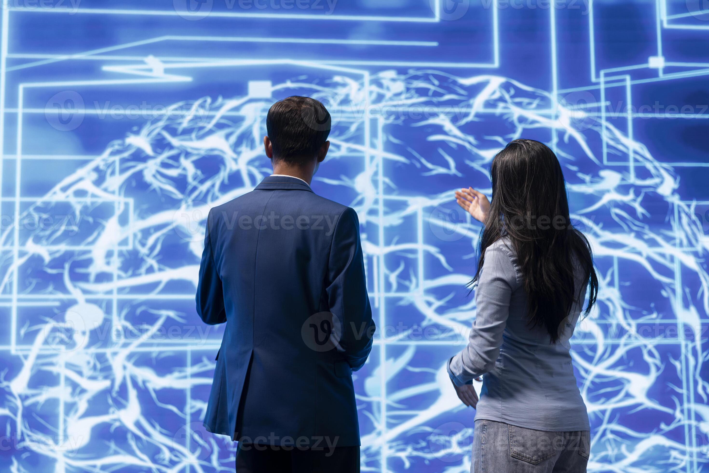 Teamworking colleagues implementing artificial intelligence parallel processing, breaking up ...