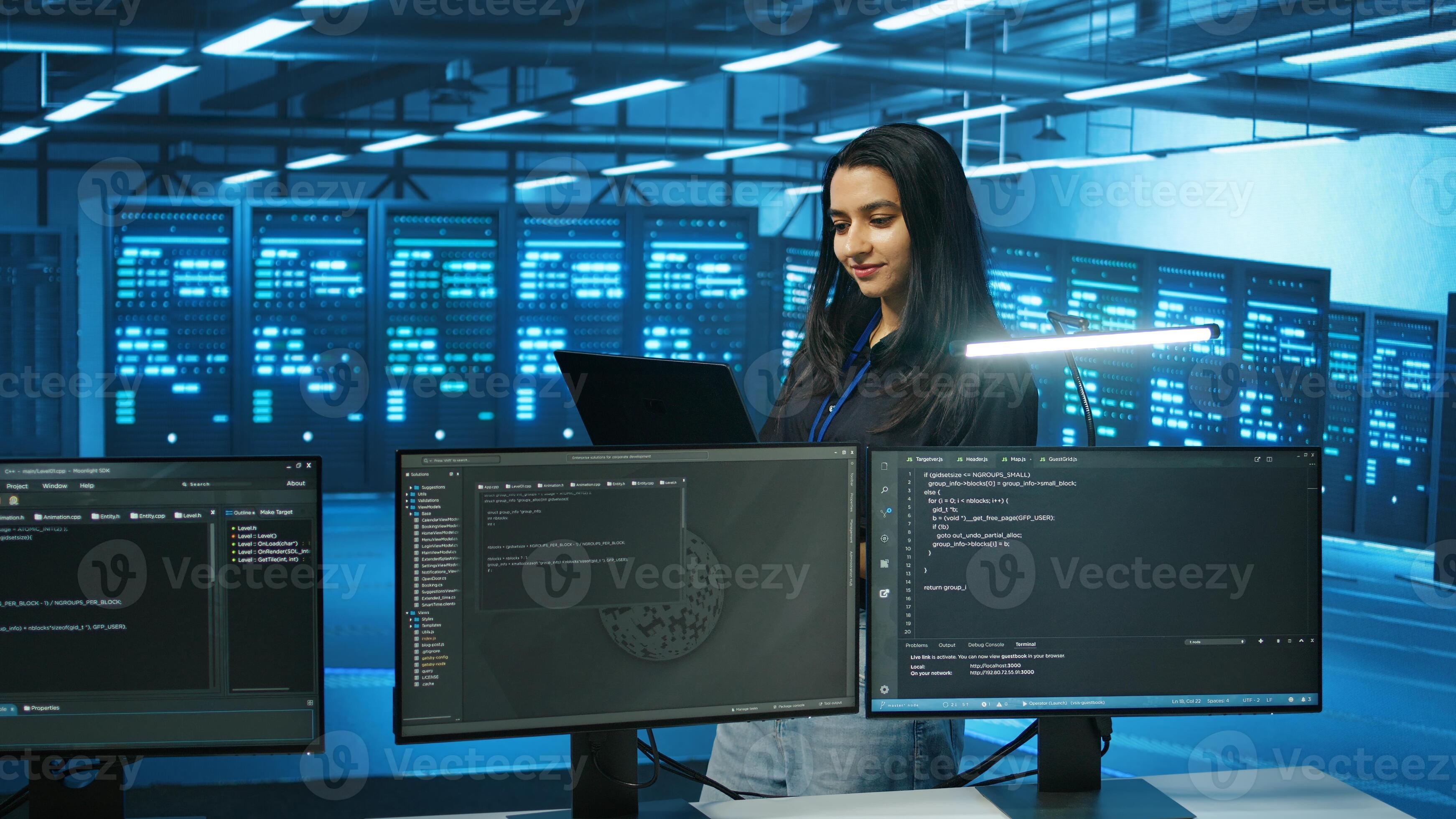 System admin working in computer network security data center, ensuring optimal performance ...