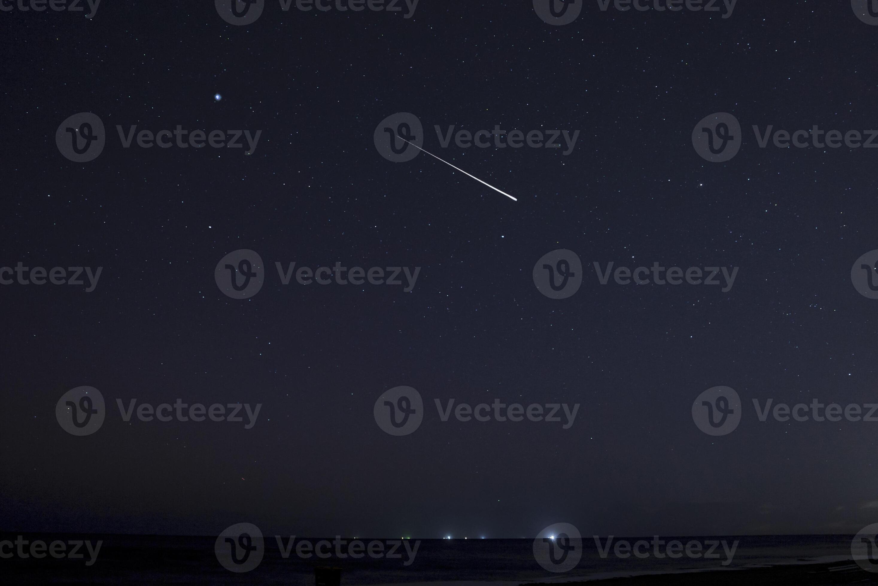 Beautiful meteors in the night sky over Latvia. Night landscape with ...