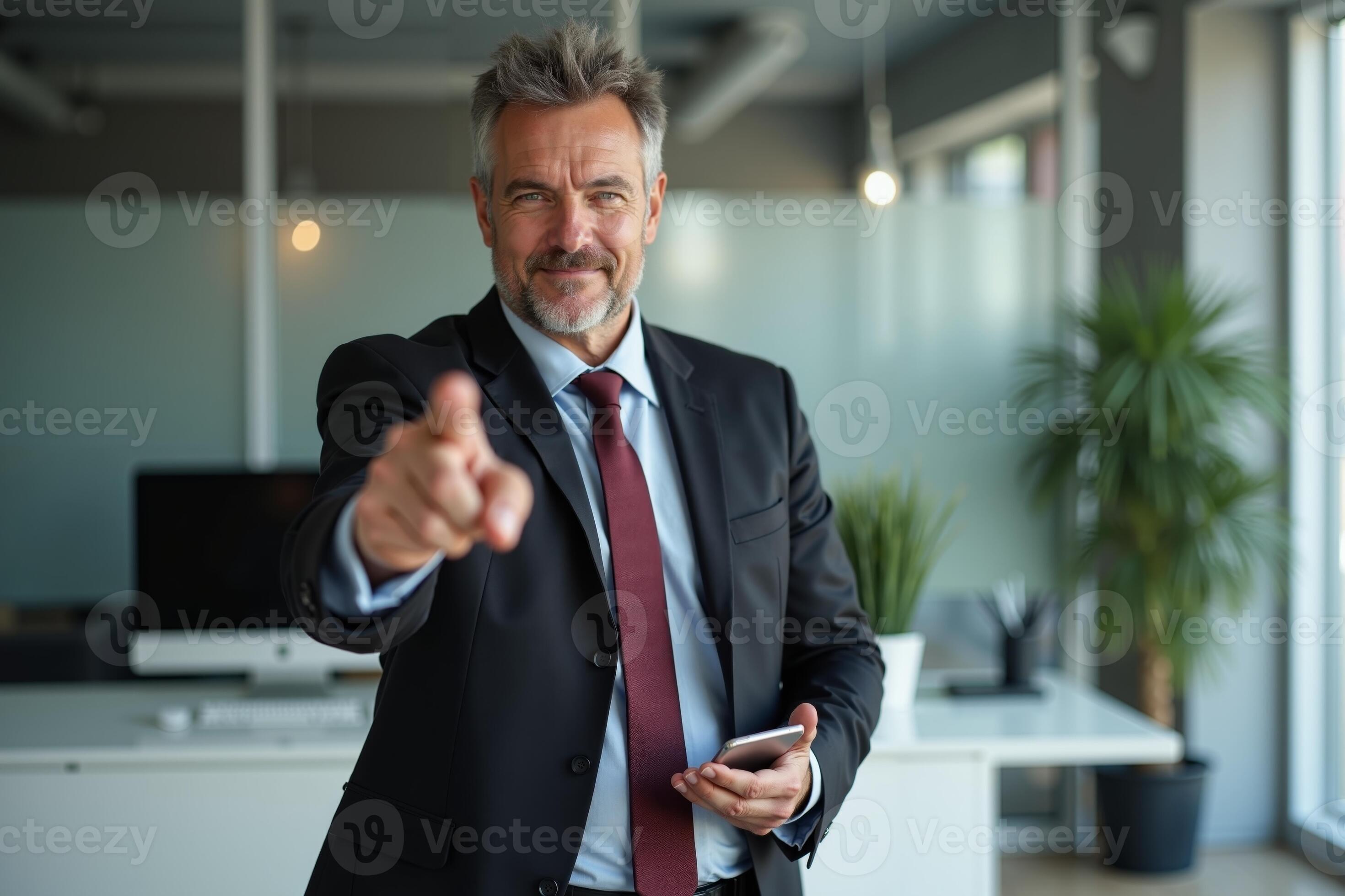 photo of man in suit outfit pointing index finger in the office ...