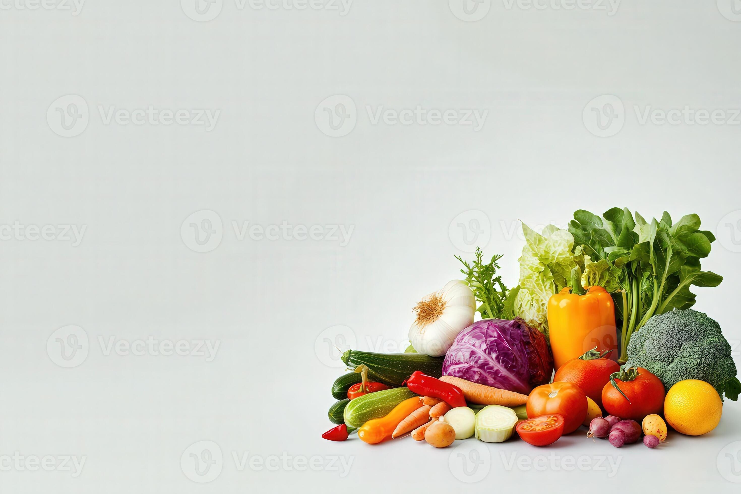 A colorful array of fresh vegetables and fruits is beautifully displayed on a clean surface ...