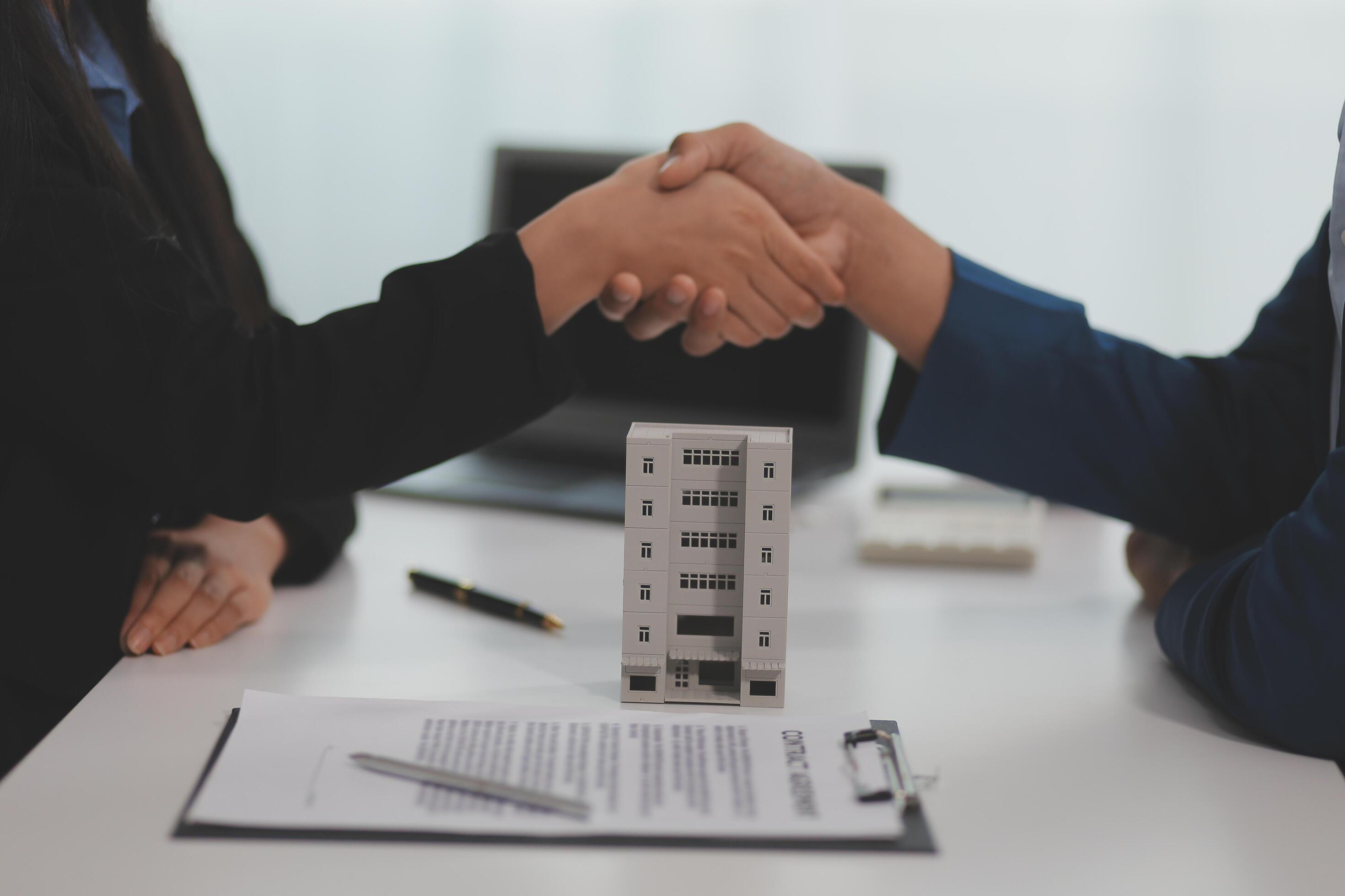 Estate agent shaking hands with customer after contract signature ... Estate agent shaking hands with customer after contract signature ...
