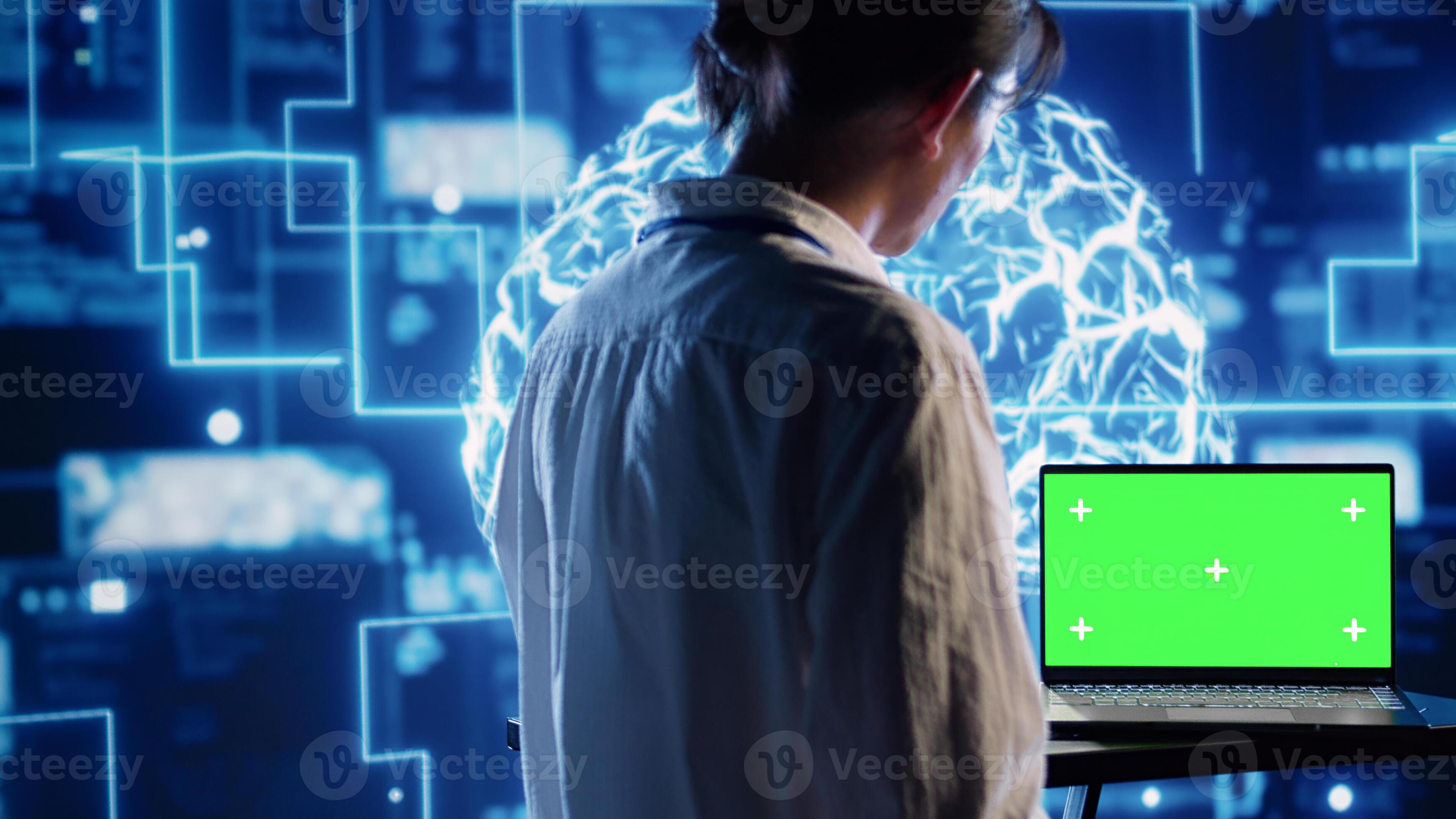 Developer using green screen laptop to implement artificial intelligence parallel processing ...