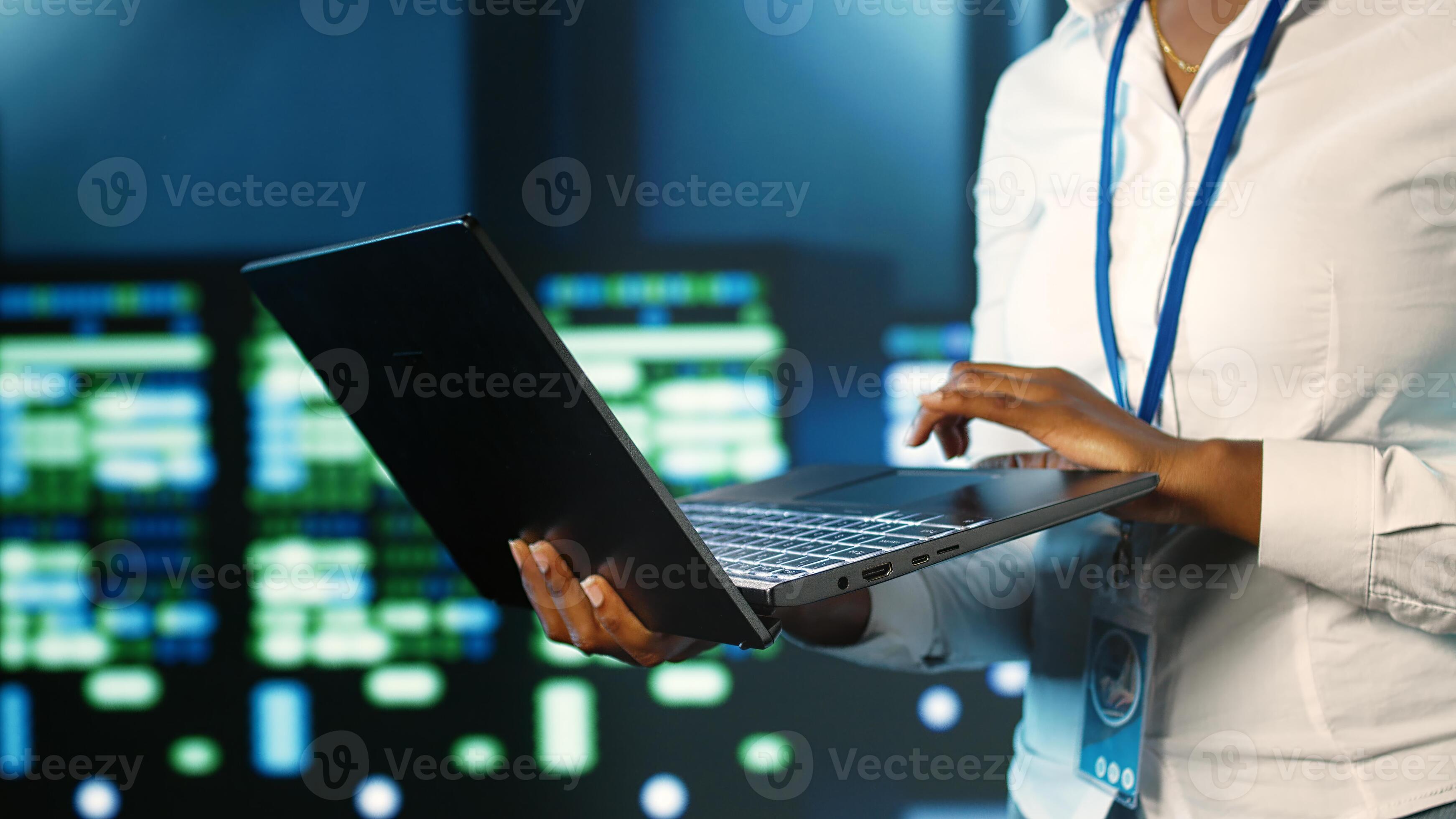 Employee strolling through data center hardware clusters providing processing resources for ...