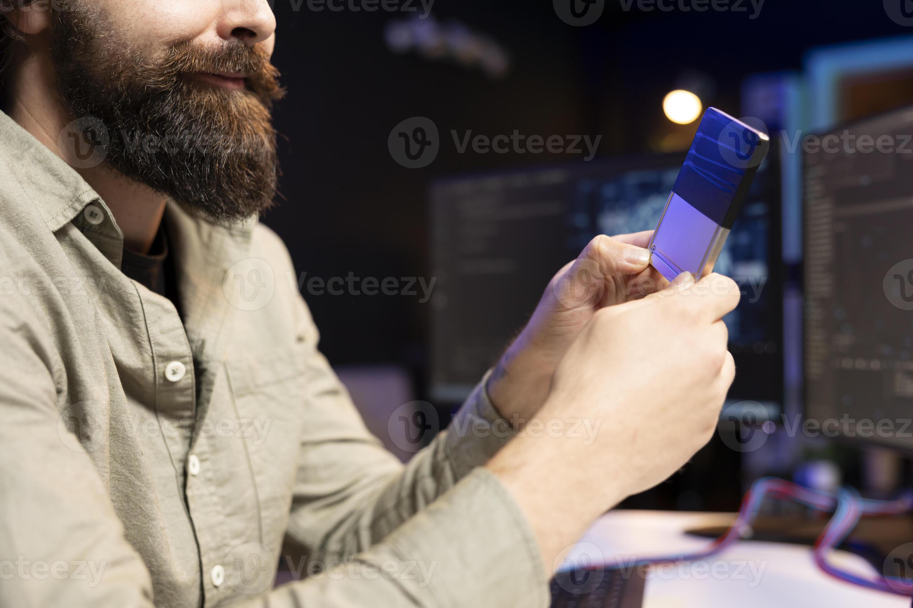 Programmer inserting disk into desktop PC containing data able to create sentient AI. Close up ...