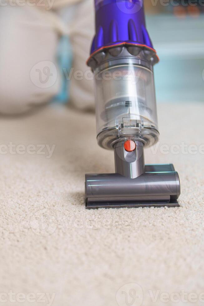Woman cleaning Carpet with cordless Vacuum cleaner. Housewife using ...