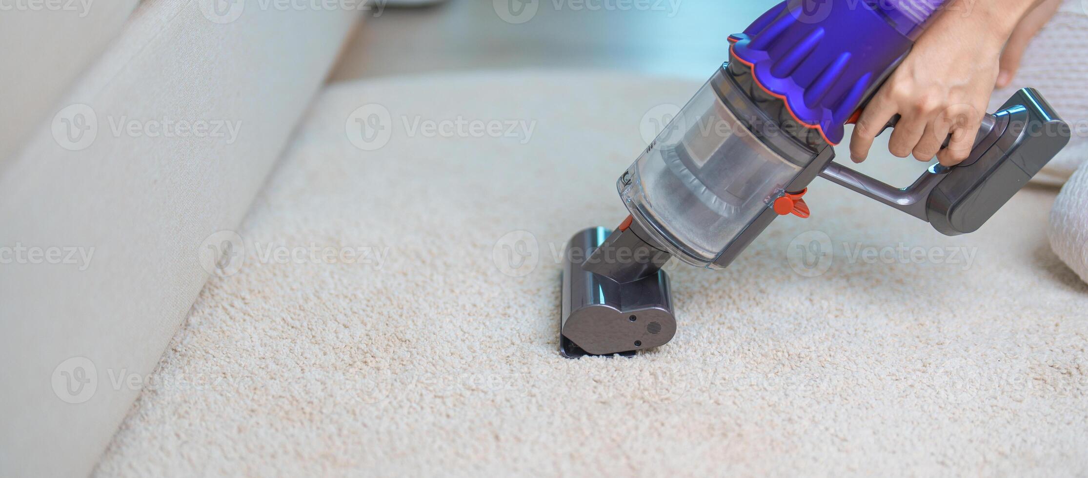 Woman cleaning Carpet with cordless Vacuum cleaner. Housewife using ...
