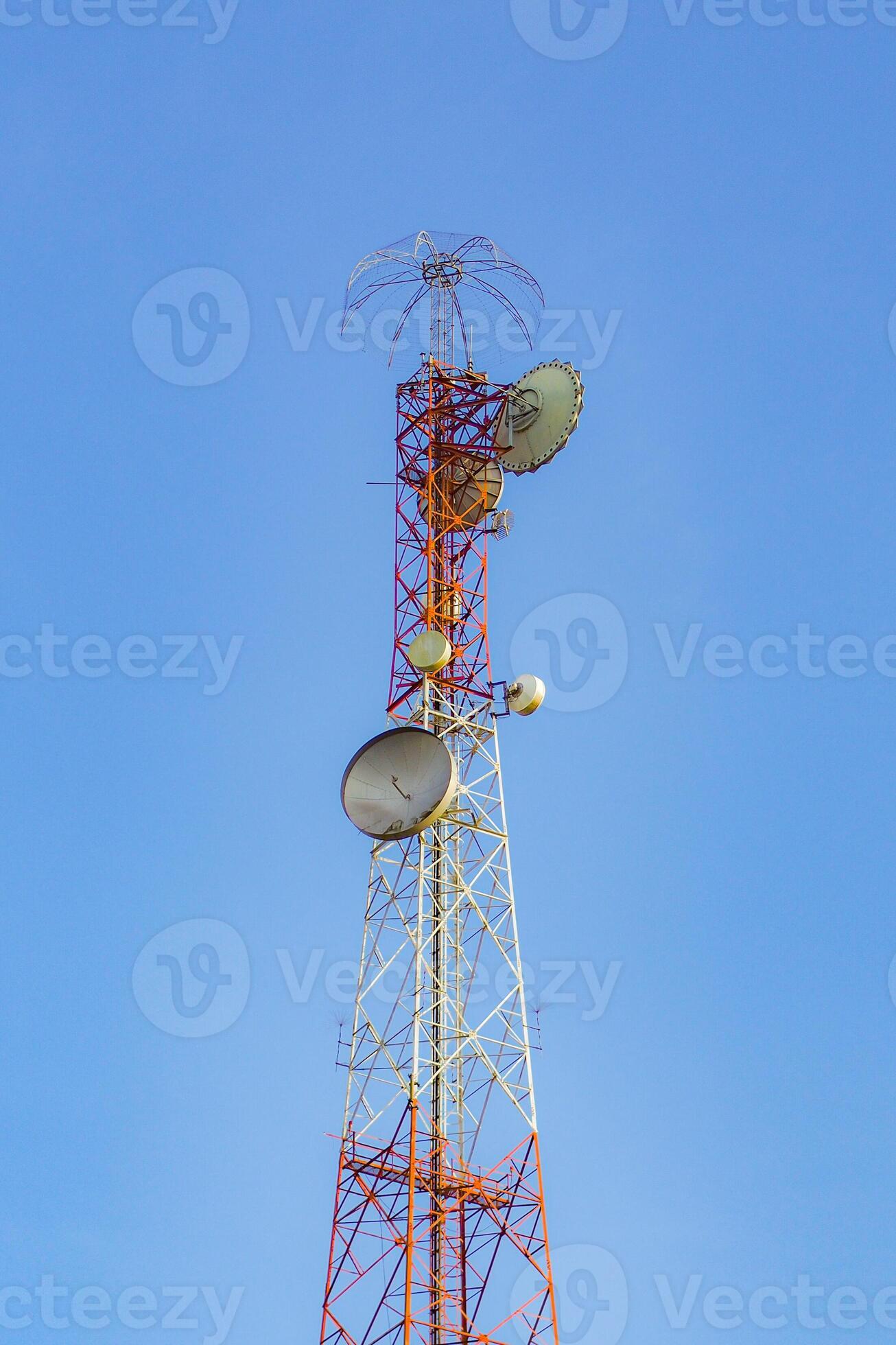 Tall Communication Tower Against Clear Blue Sky with Satellite Dishes and Antennas for ...