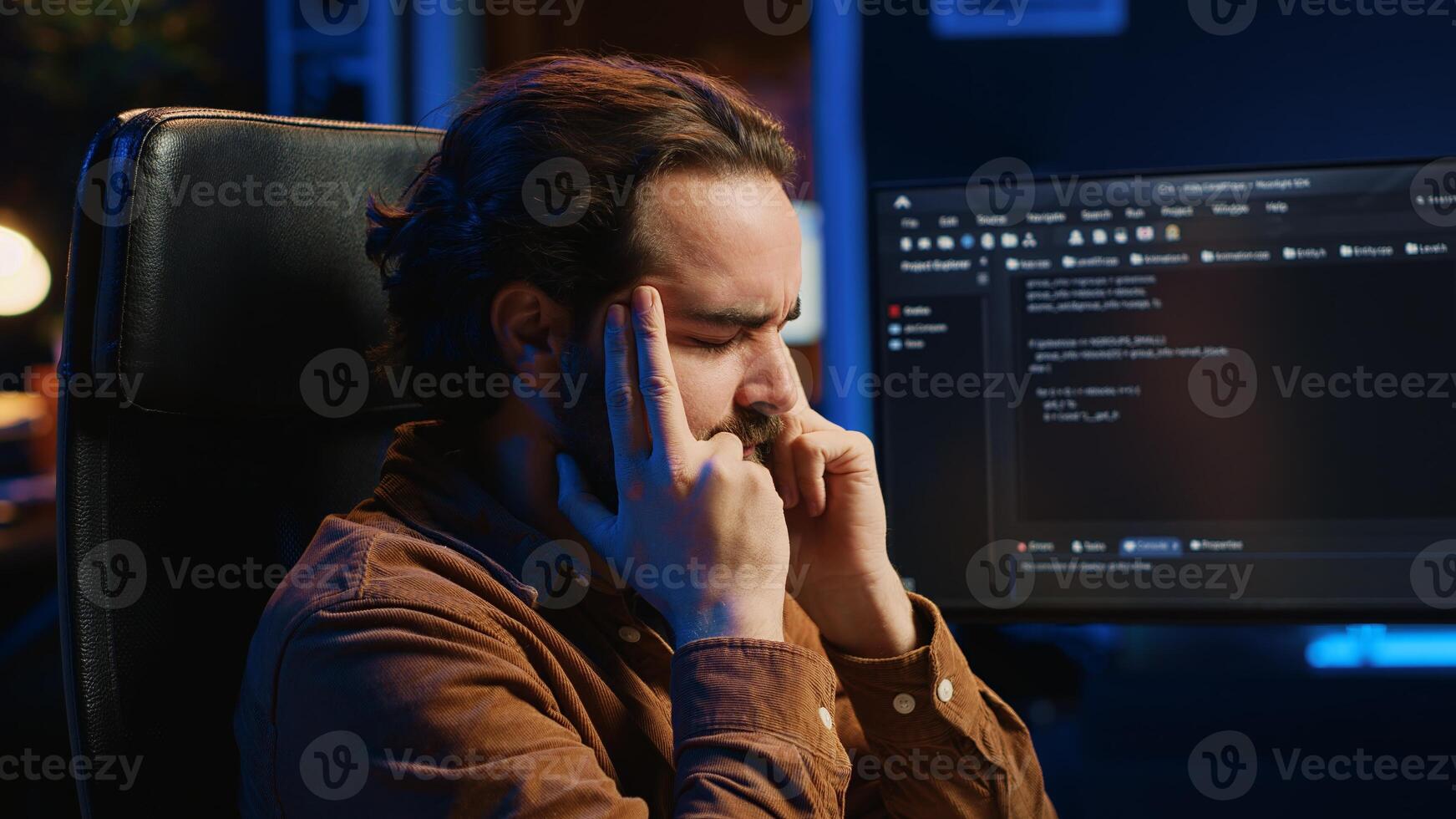 Annoyed software technician rubbing temples in frustration after ... Annoyed software technician rubbing temples in frustration after ...