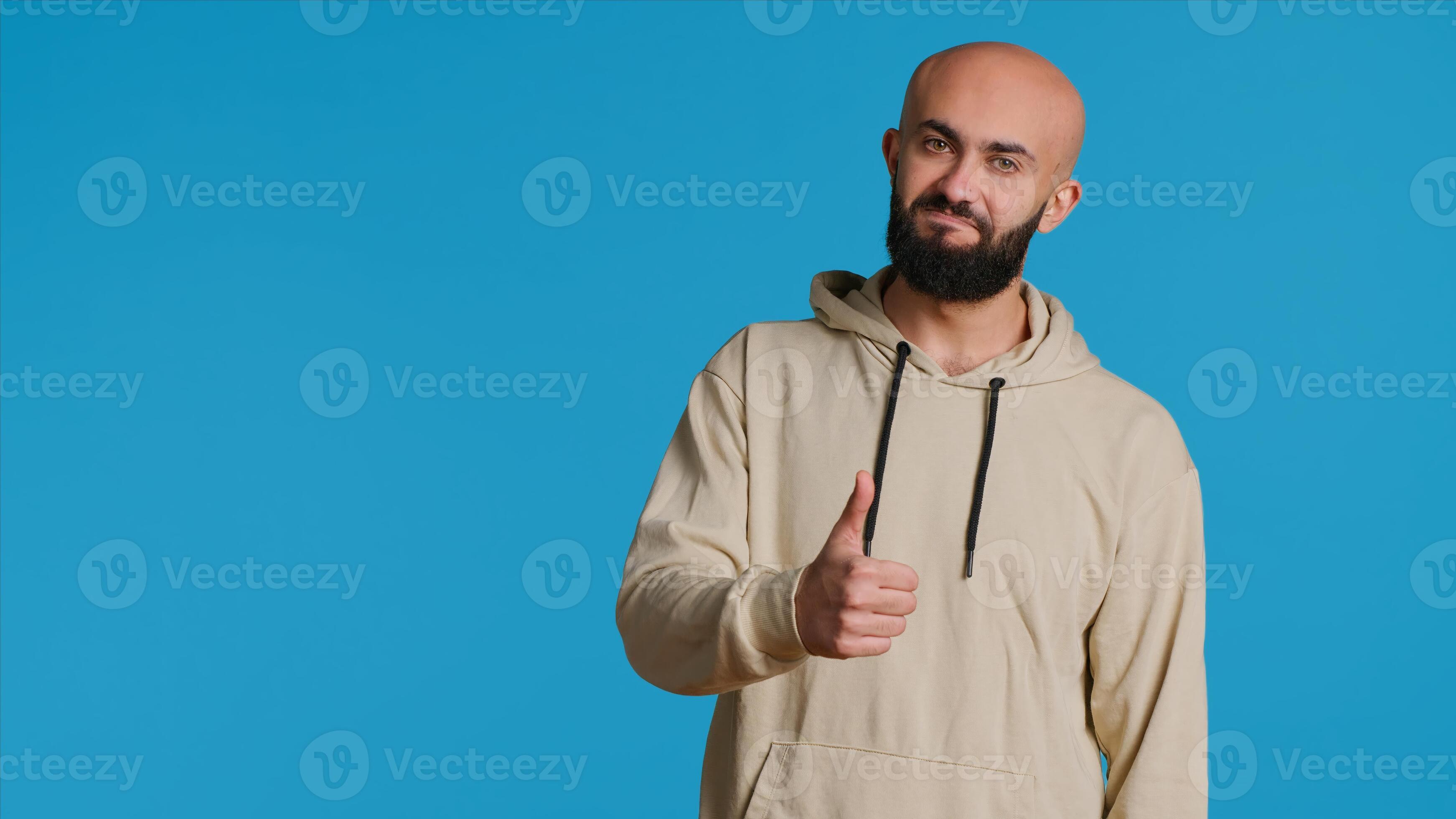 Middle eastern person does thumbs up sign on camera, expressing his ... Middle eastern person does thumbs up sign on camera, expressing his ...