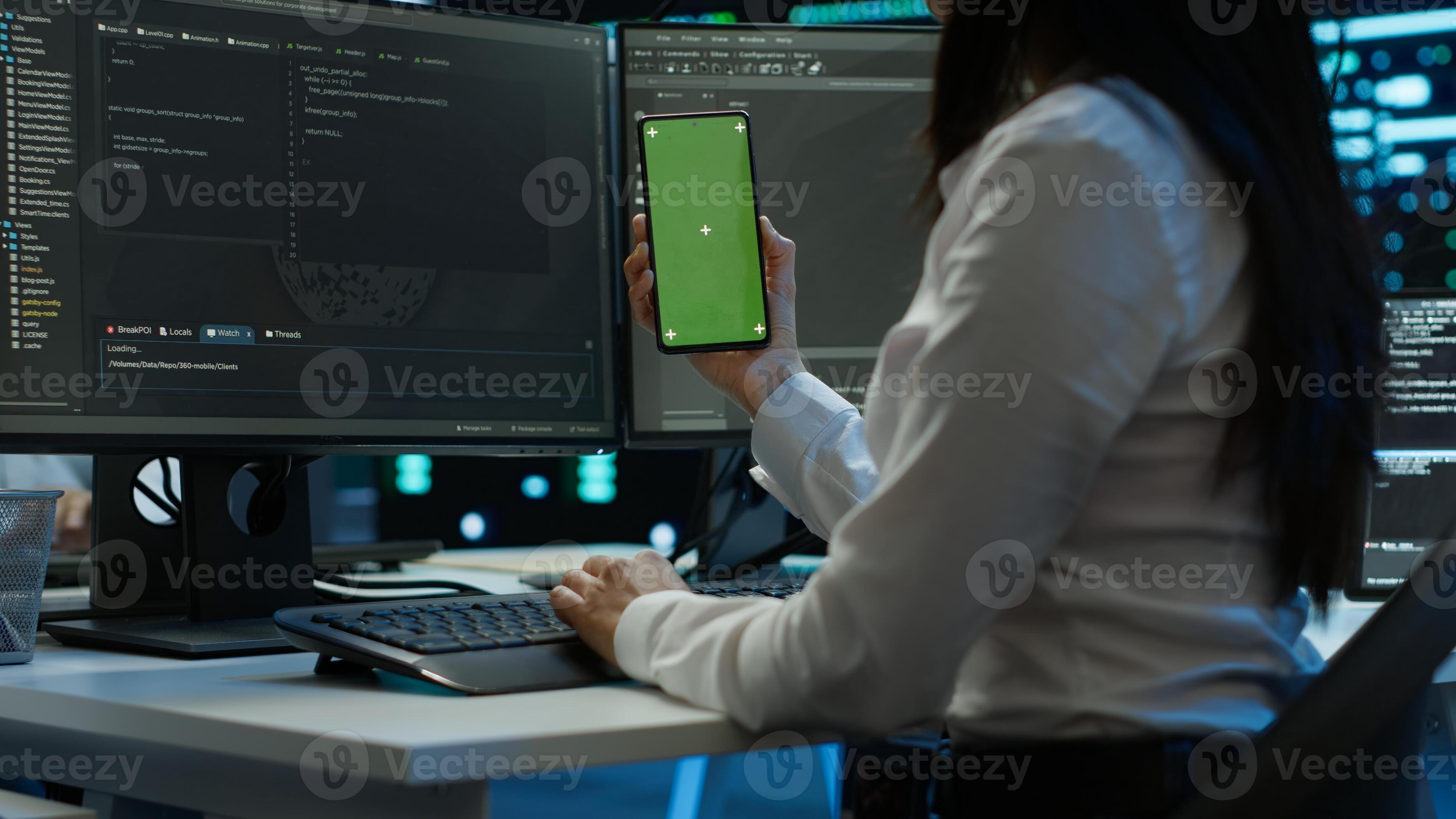 Worker Overseeing Data Center Using Green Screen Mobile Phone Ensuring System Can Handle