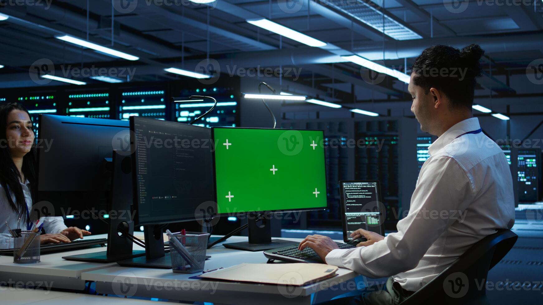Engineer In Data Center Monitoring Security Threats Using Mockup Computer Implementing