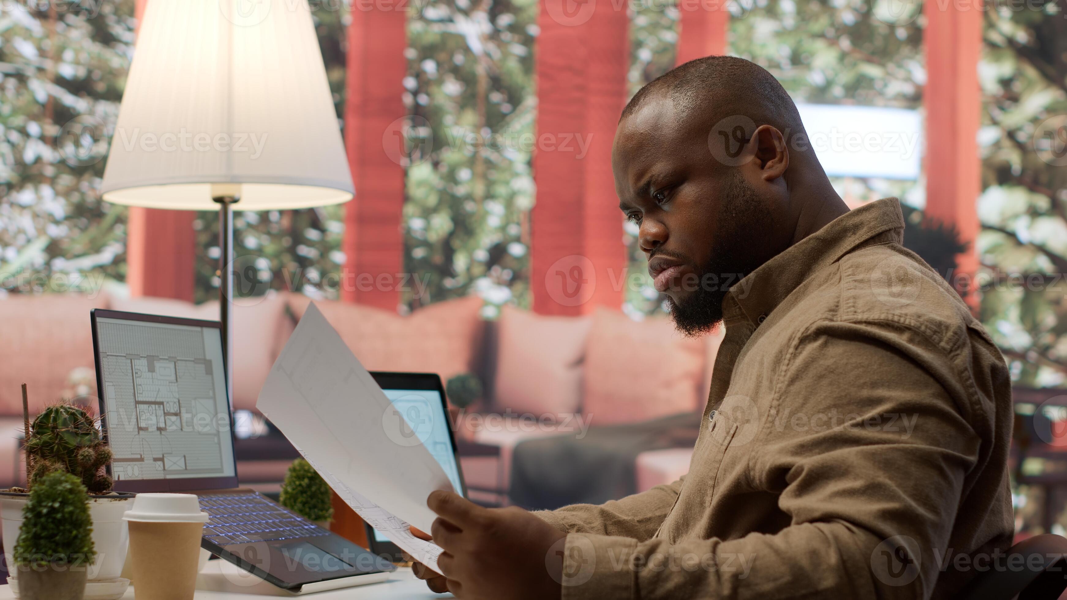 Businessman Evaluating Architectural Blueprints For A Modern Office