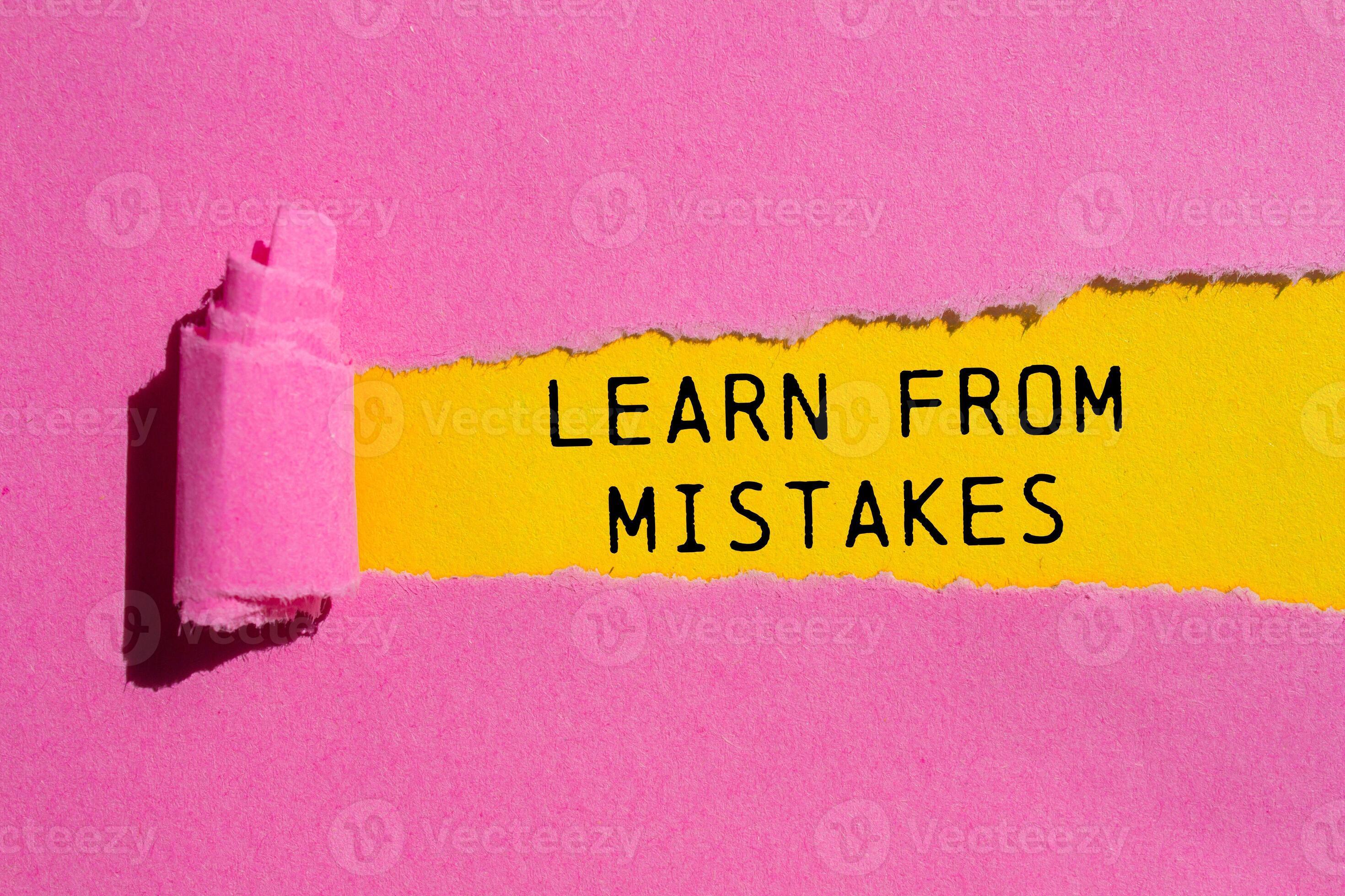 Learn from mistakes message written on ripped torn pink paper with ...