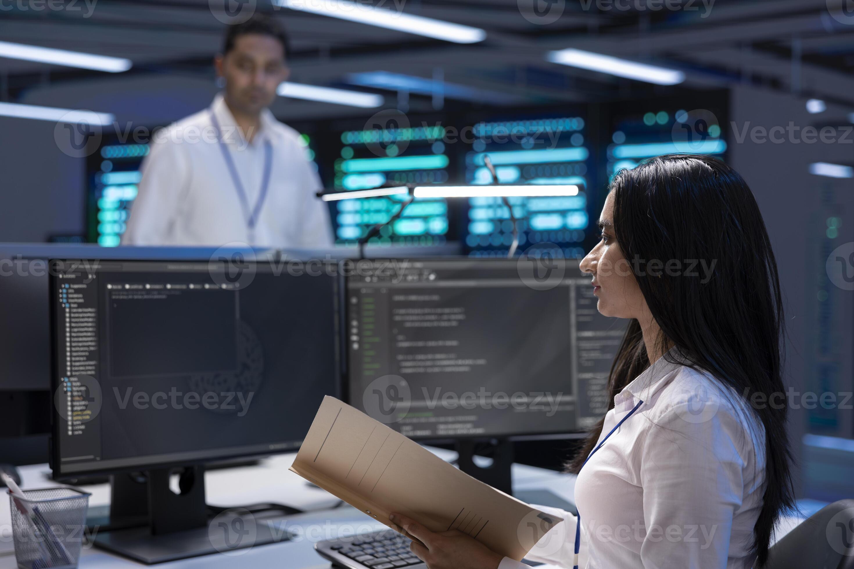 IT supervisor verifying data center gear documentation files, ensuring proper configurations and ...