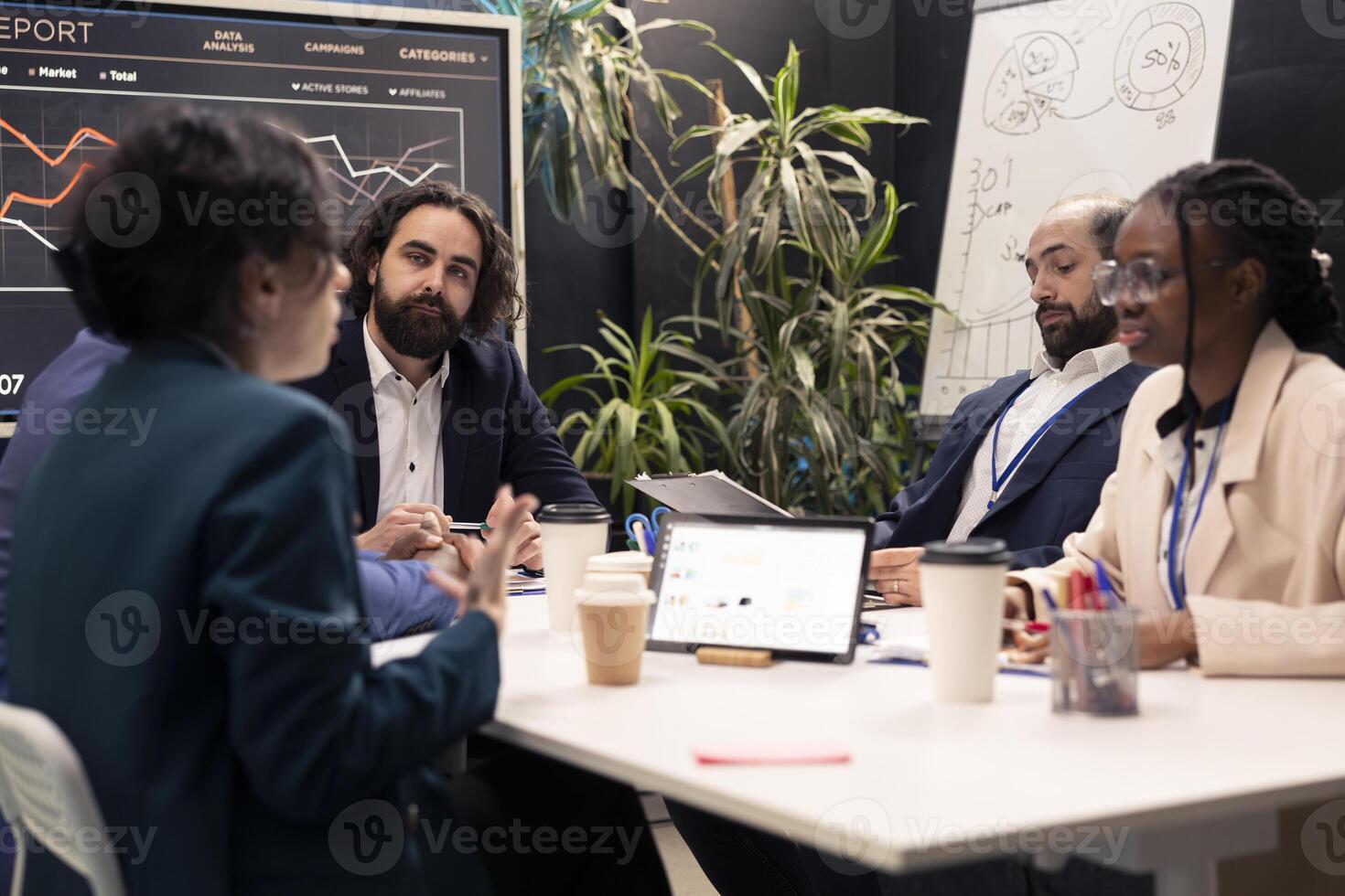 Operations team evaluating success and performance indicators on ... Operations team evaluating success and performance indicators on ...