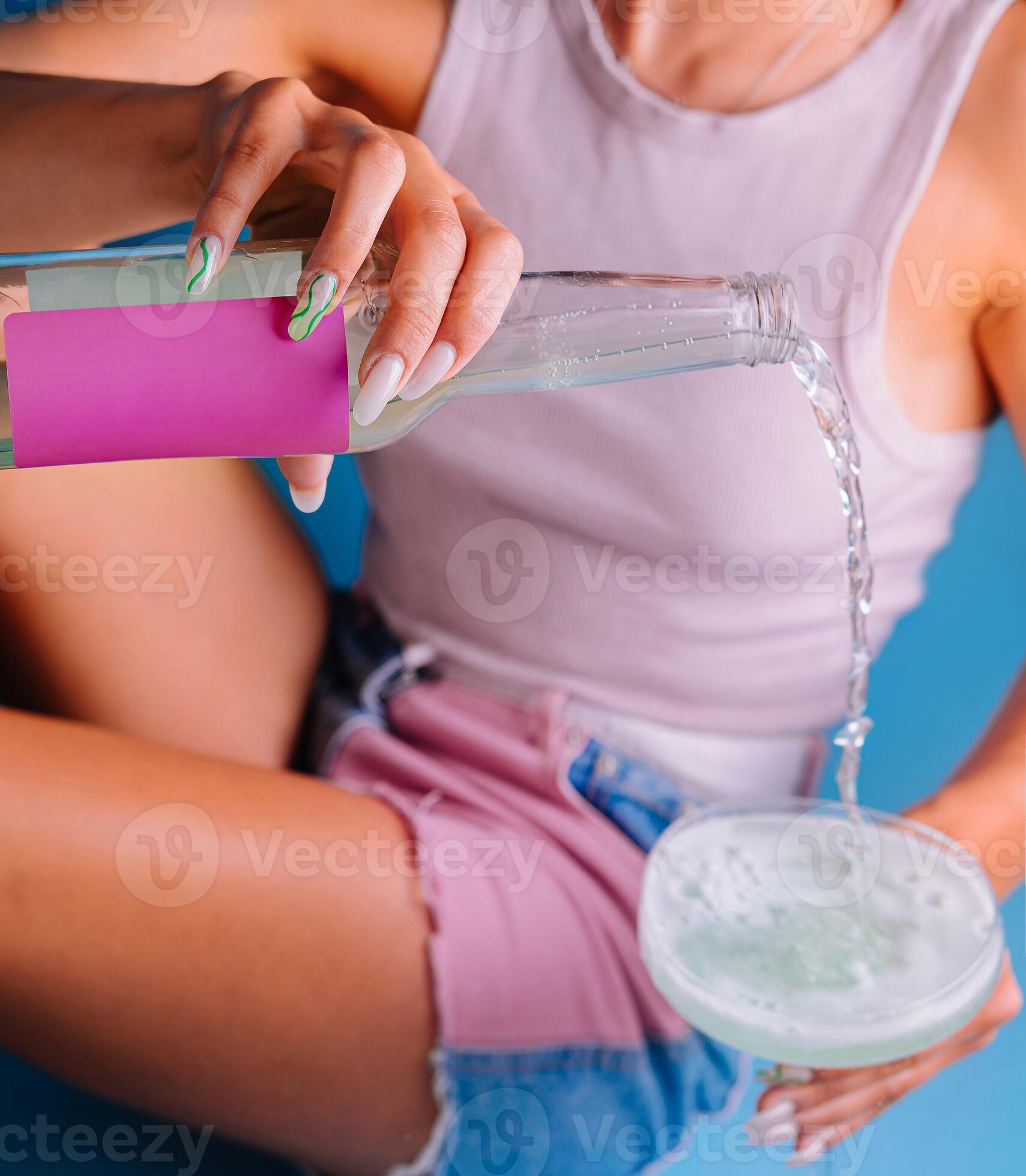 Woman pouring sparkling water from bottle with blank label into glass 50335469 Stock Photo at ...