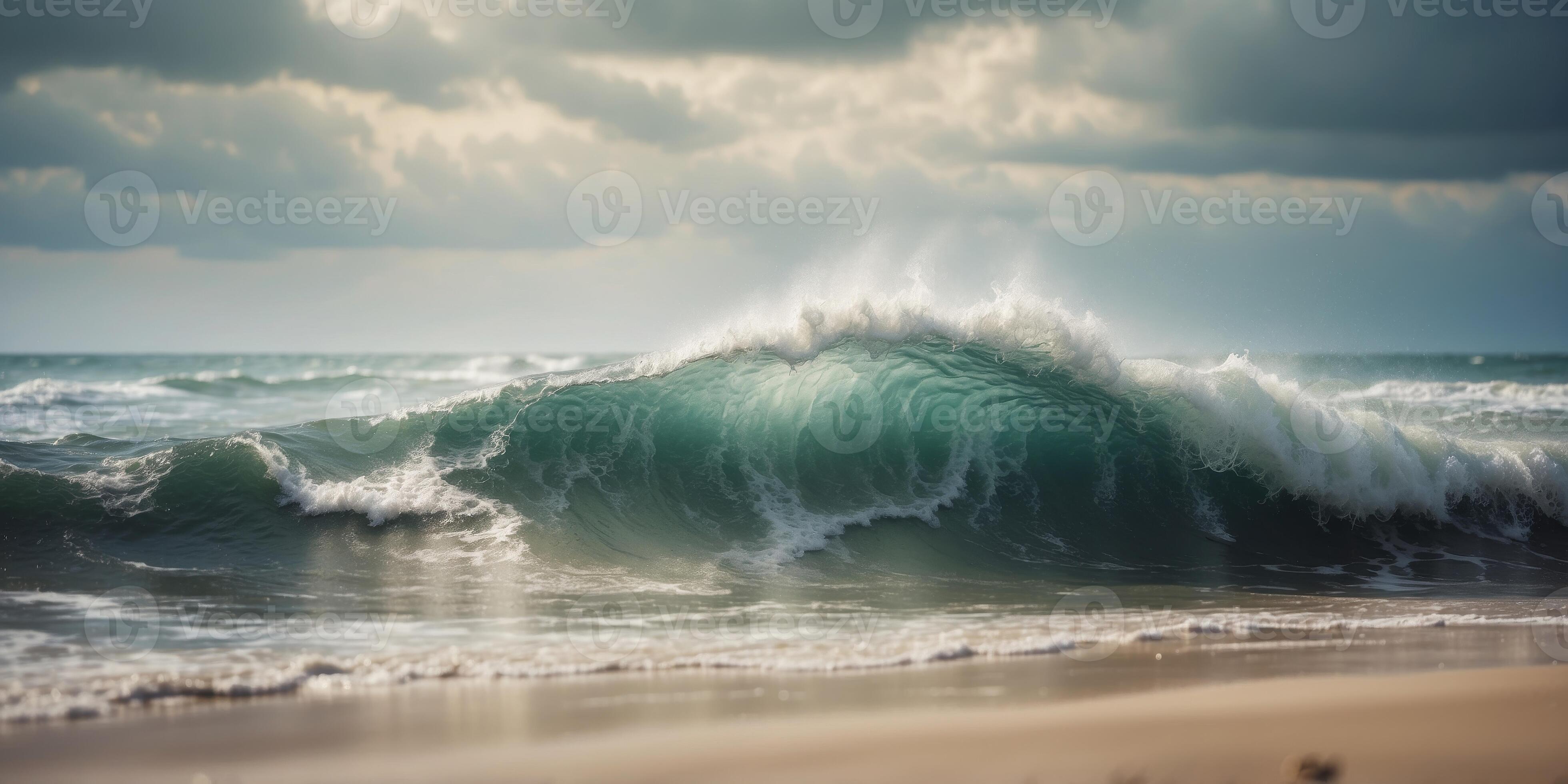 A large wave crashes into a beach's shore under a cloudy sky - two ...