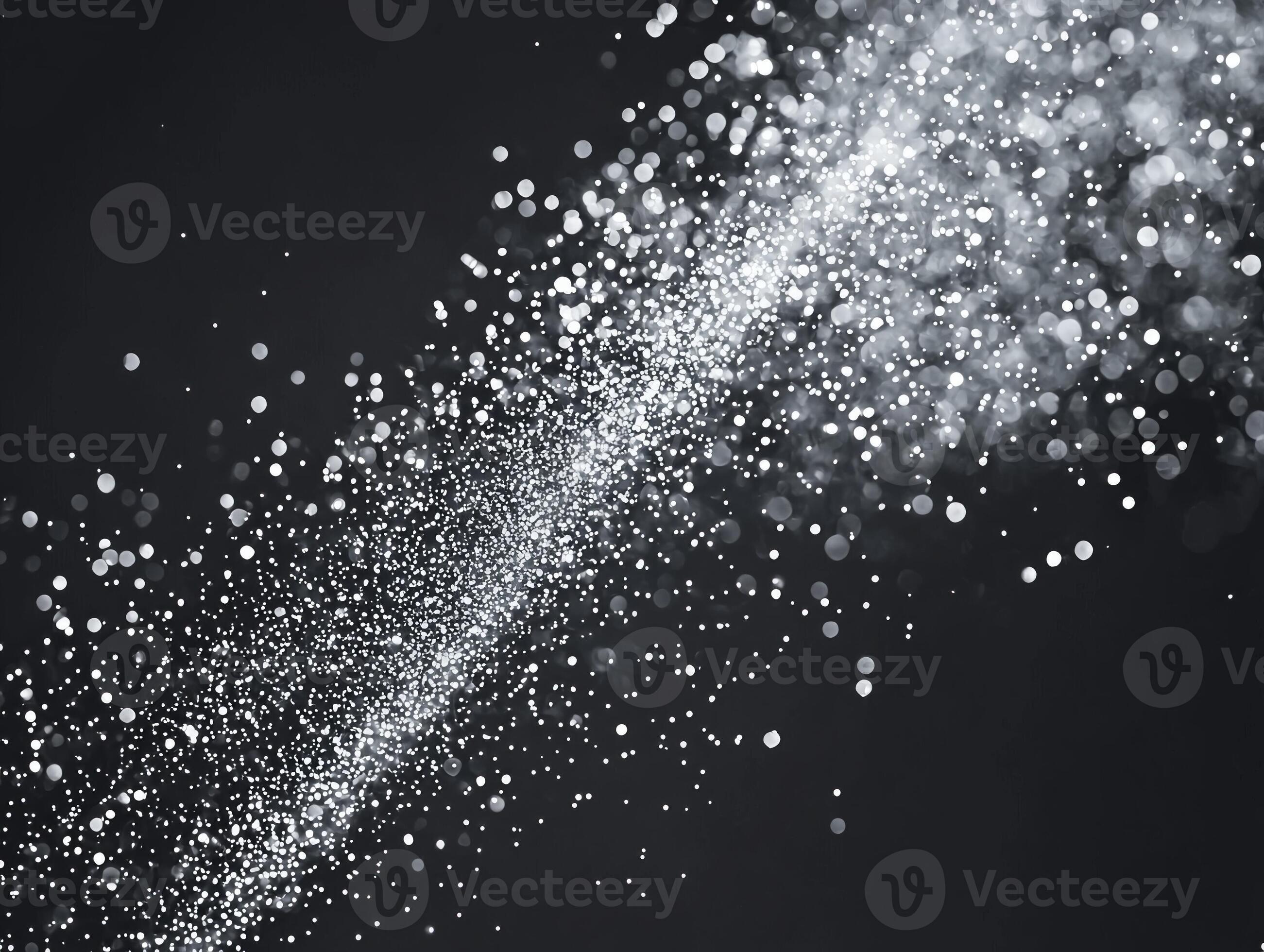 A dynamic scattering of silver particles creates a captivating cosmic ...