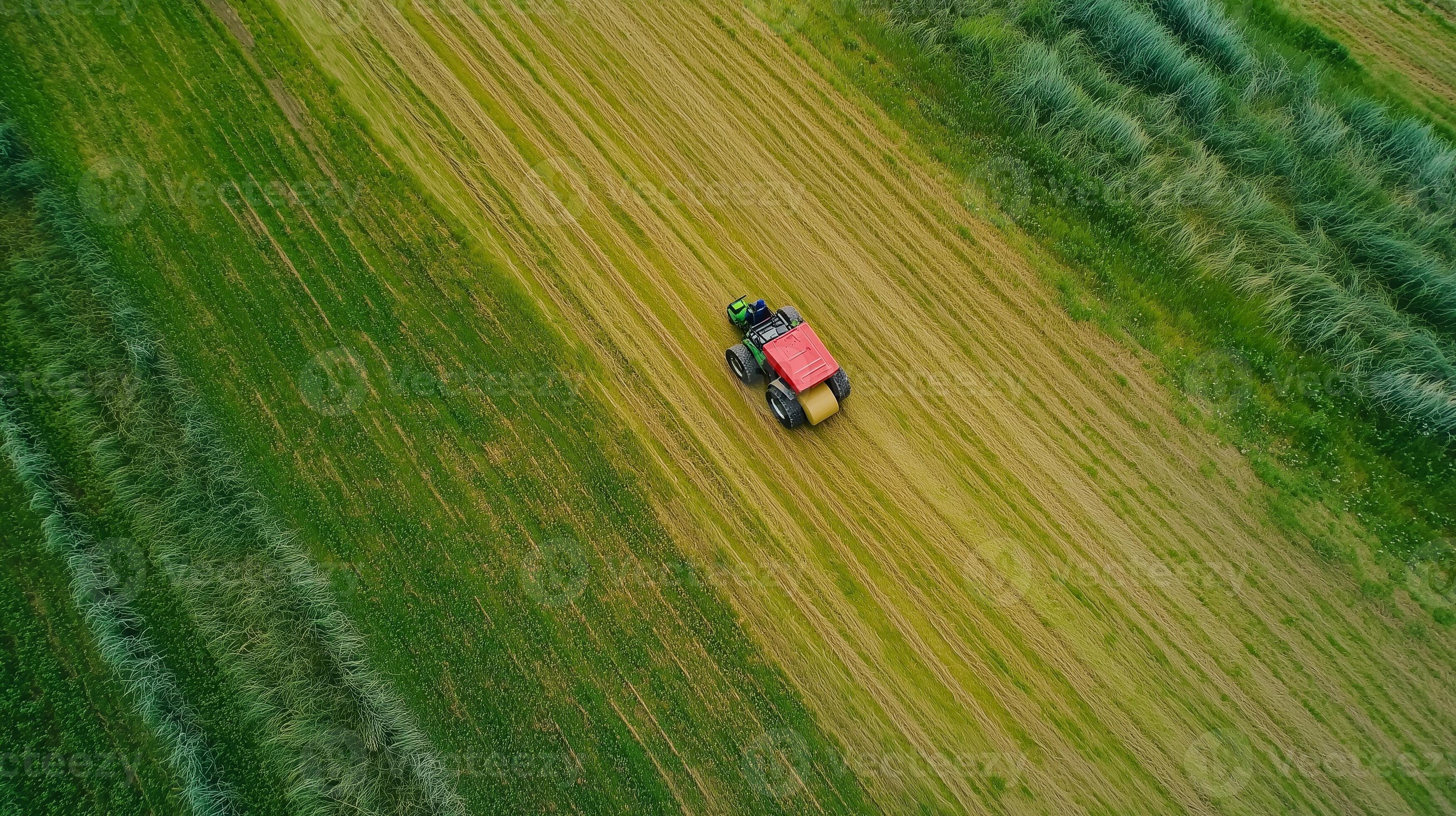 Aerial View Of A Red Tractor Working In A Lush Green Field During The