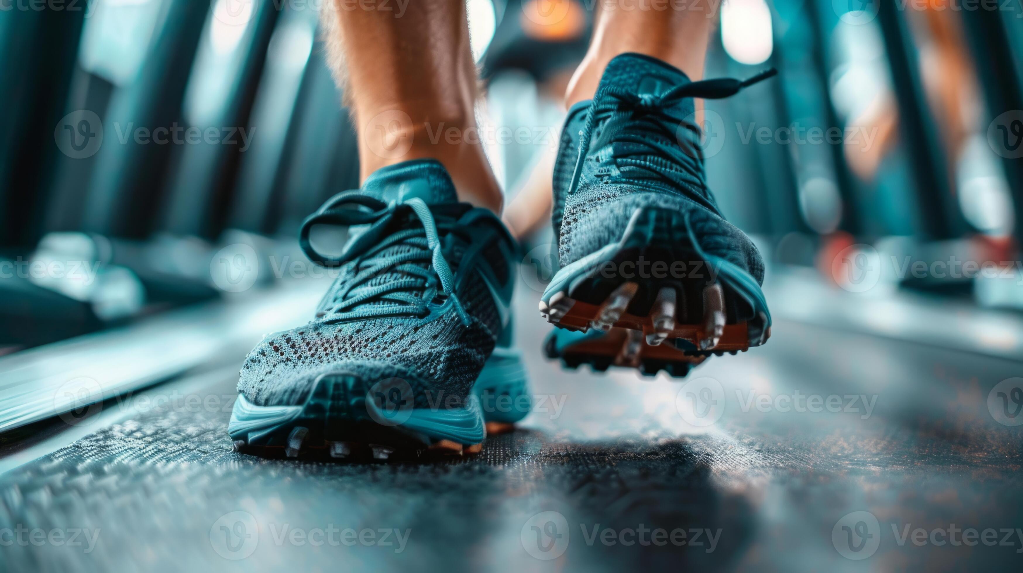 A close-up photo of a persons feet wearing blue running shoes on a ...