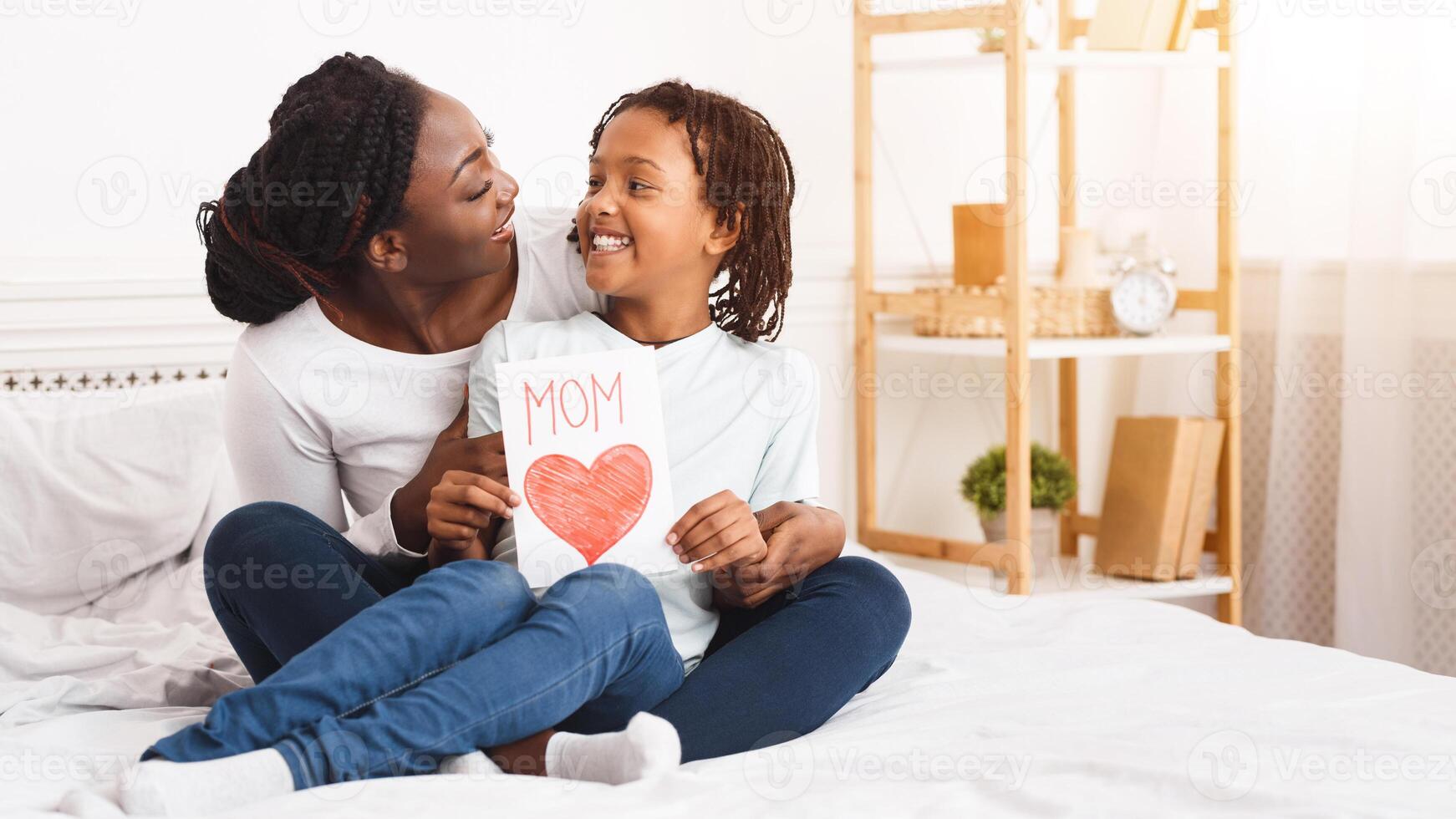 I Love You, Mommy. Happy black mother hugging her little daughter and holding greeting card ...