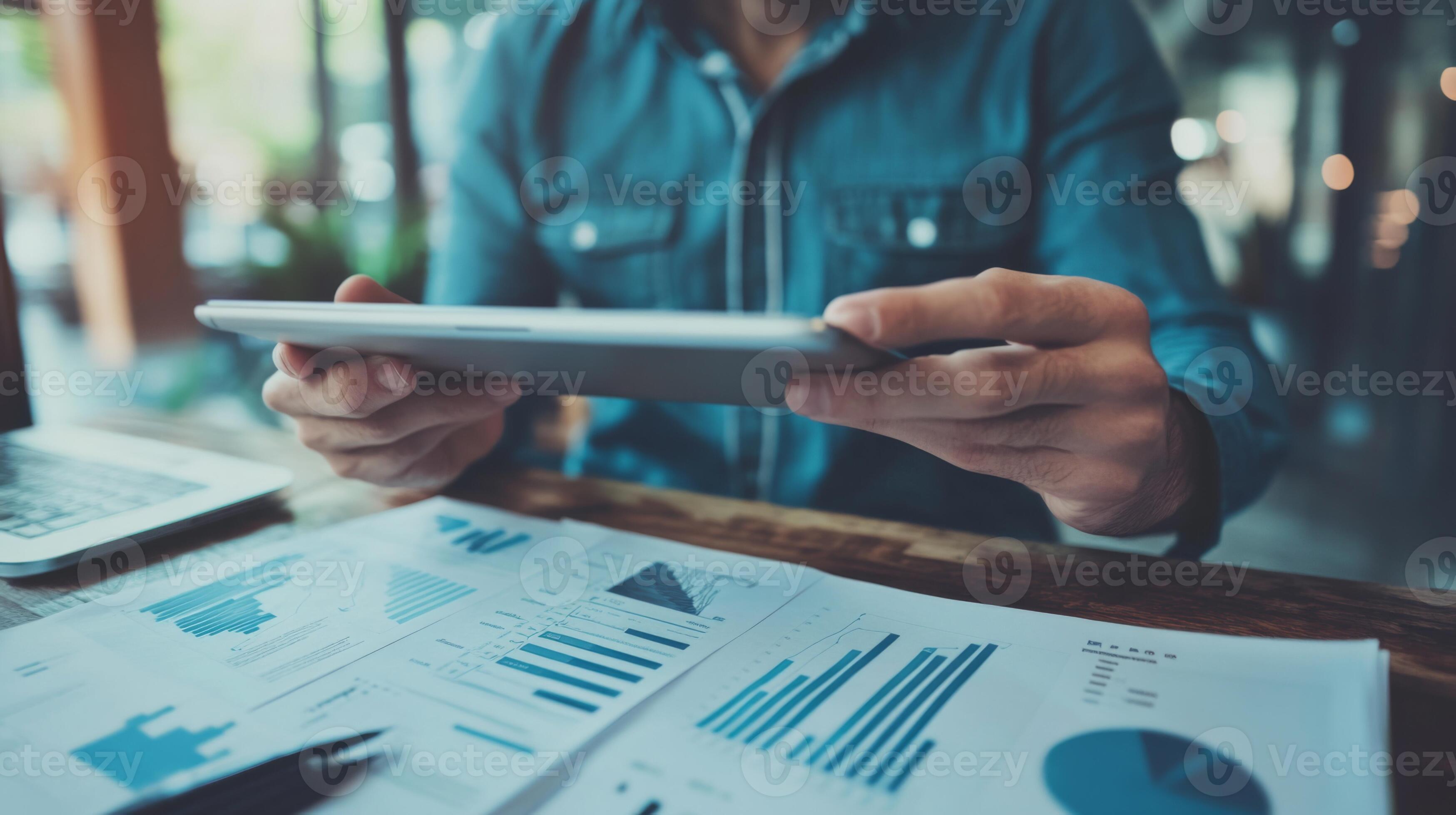 A Man Analyzing Data on a Tablet and Spreadsheets 50948220 Stock Photo at Vecteezy