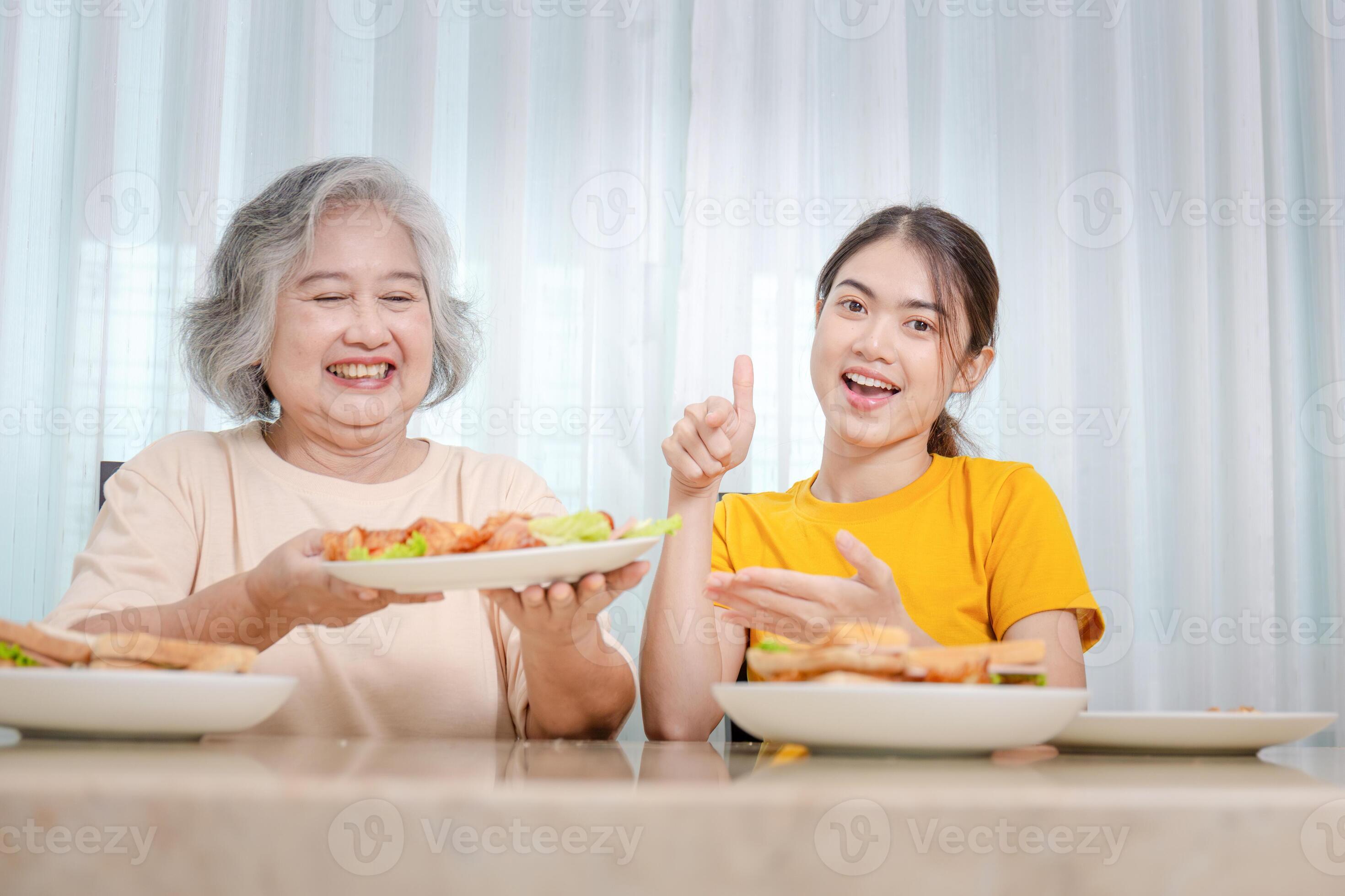 Senior asian mother and middle aged daughter enjoying with foods on table 51011714 Stock Photo ...