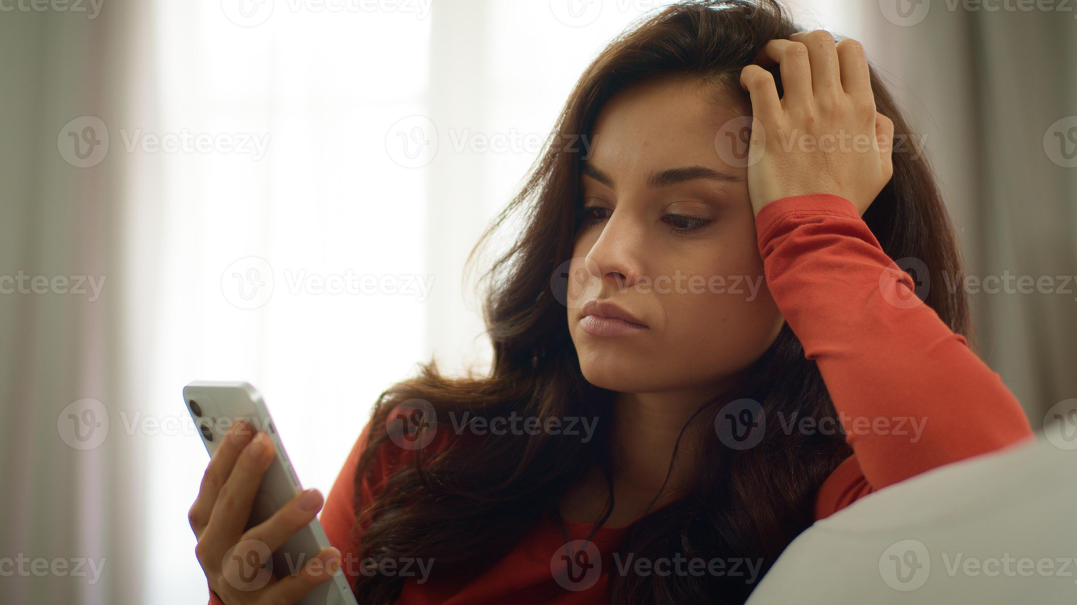 Bored sad Caucasian upset woman lazy female girl unhappy client user scrolling mobile phone ...