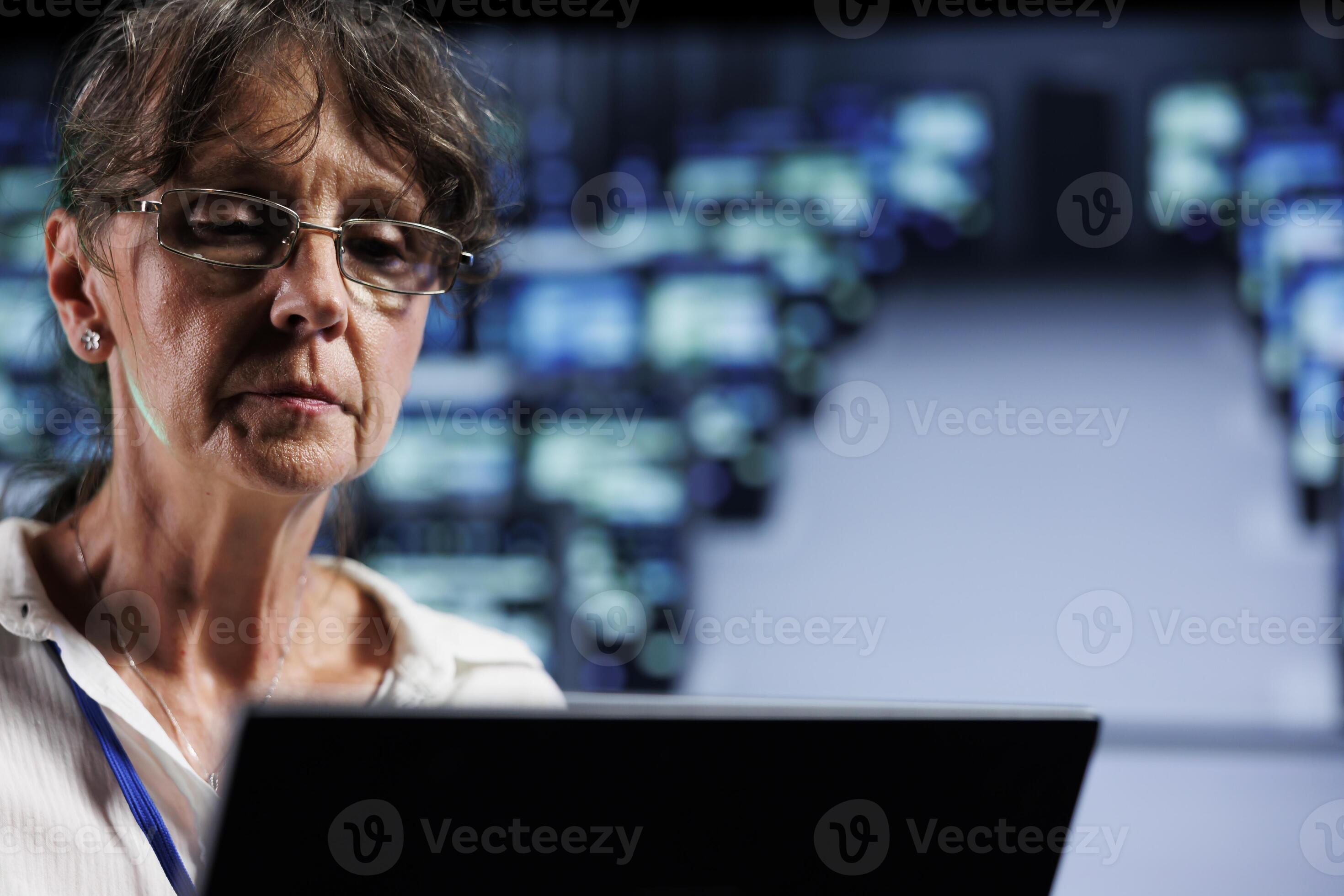 Elderly It Developer In Data Center Working On Laptop Setting Up High