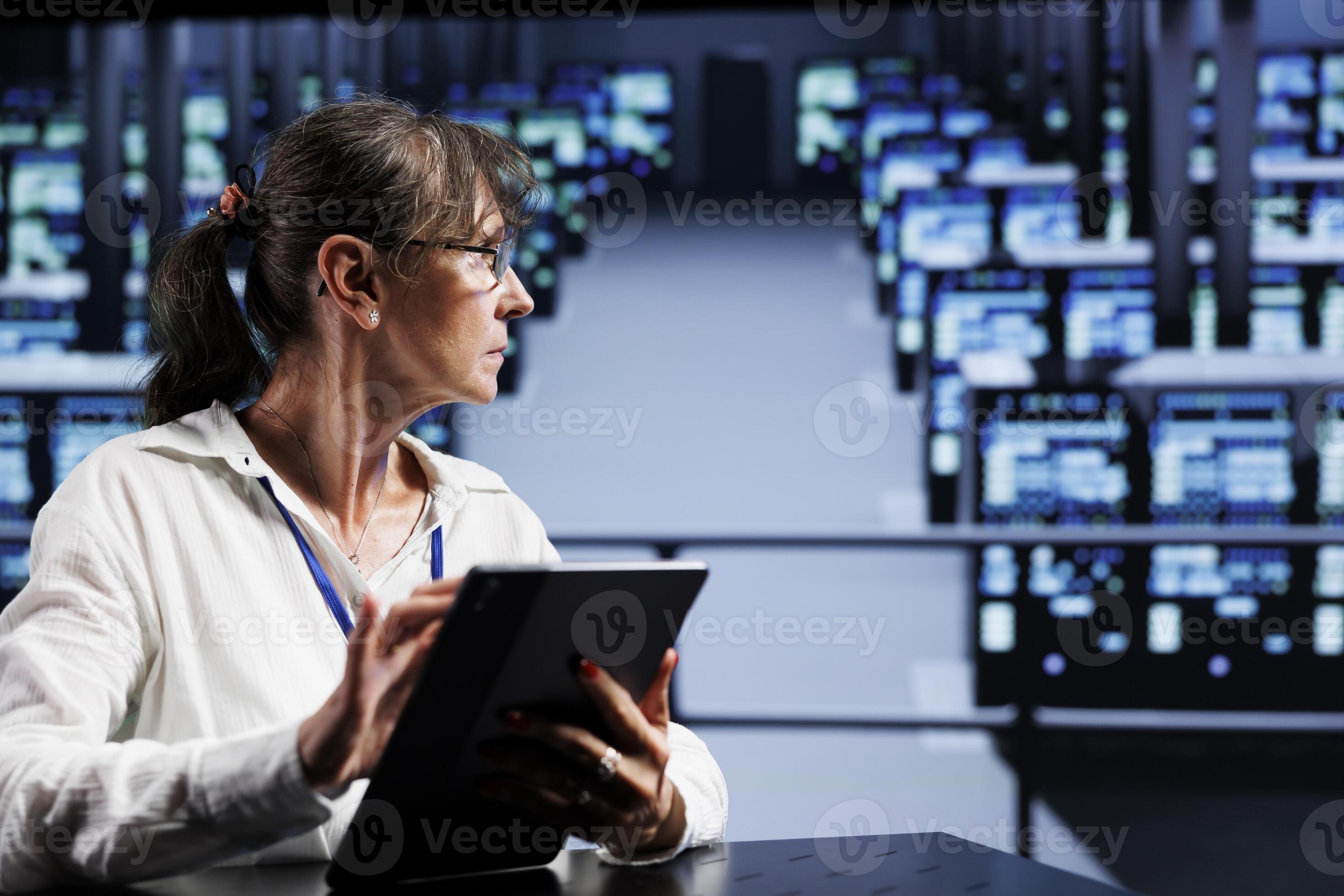 Trained engineer preparing server mainframes contingency plan, monitoring data center energy ...