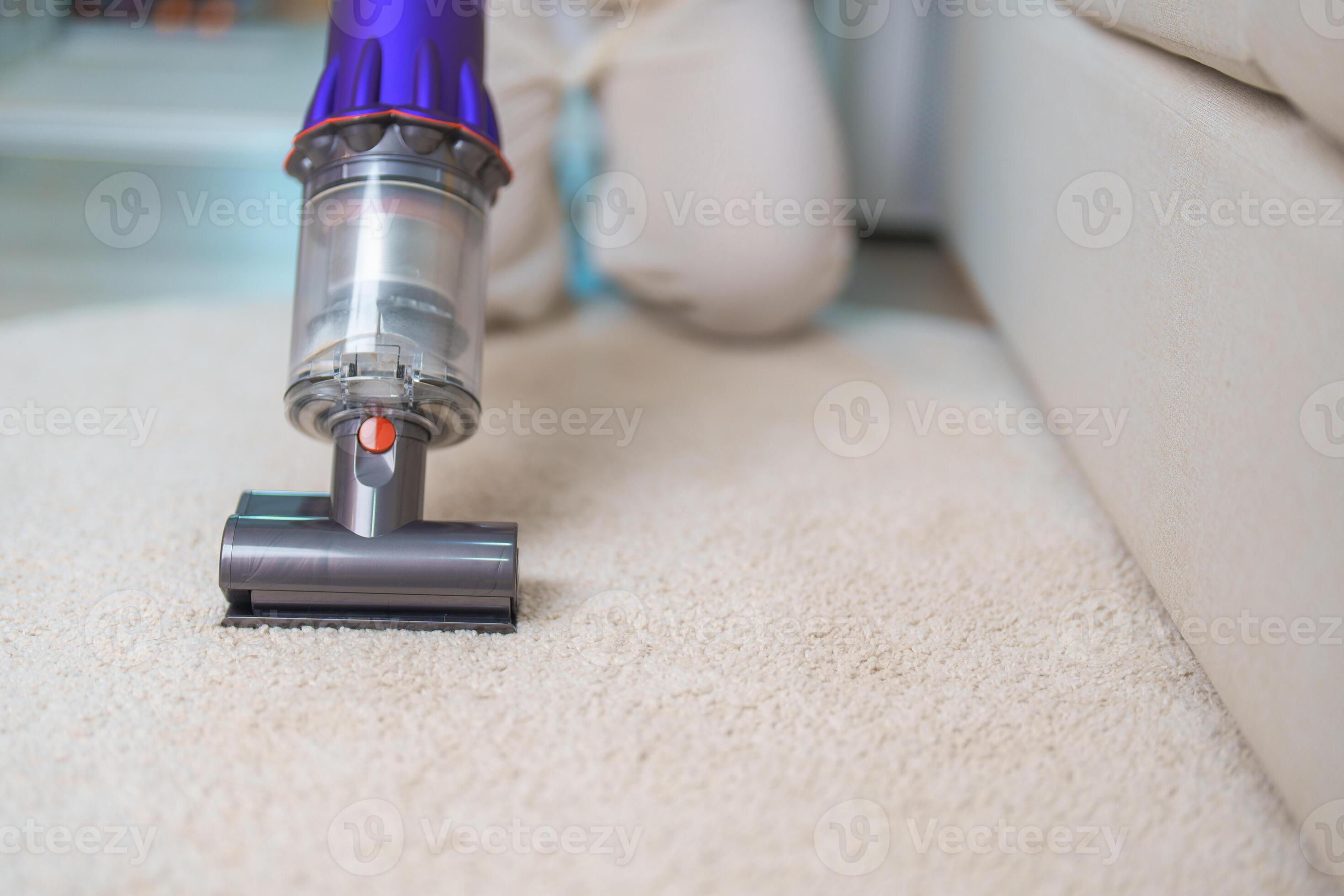 Woman cleaning Carpet with cordless Vacuum cleaner. Housewife using ...