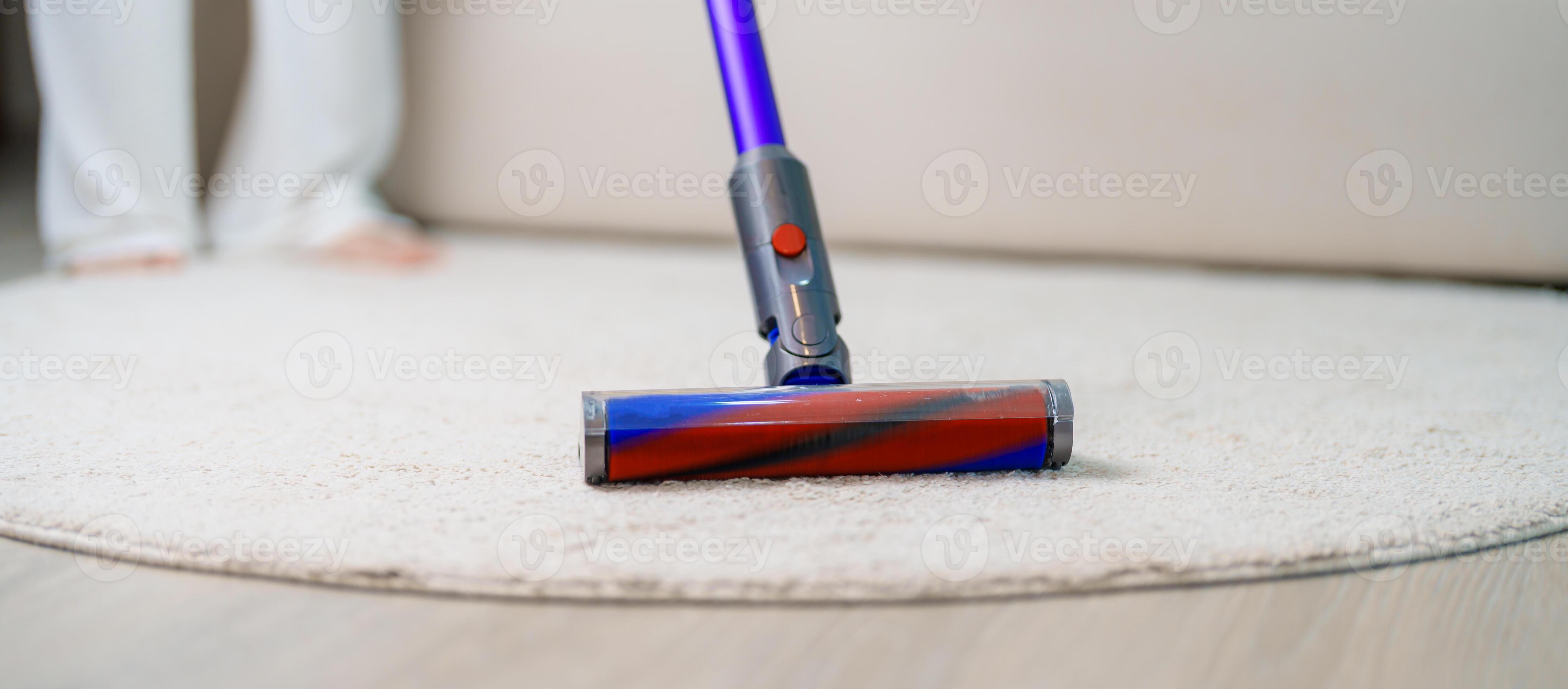Woman cleaning Carpet with cordless Vacuum cleaner. Housewife using ...