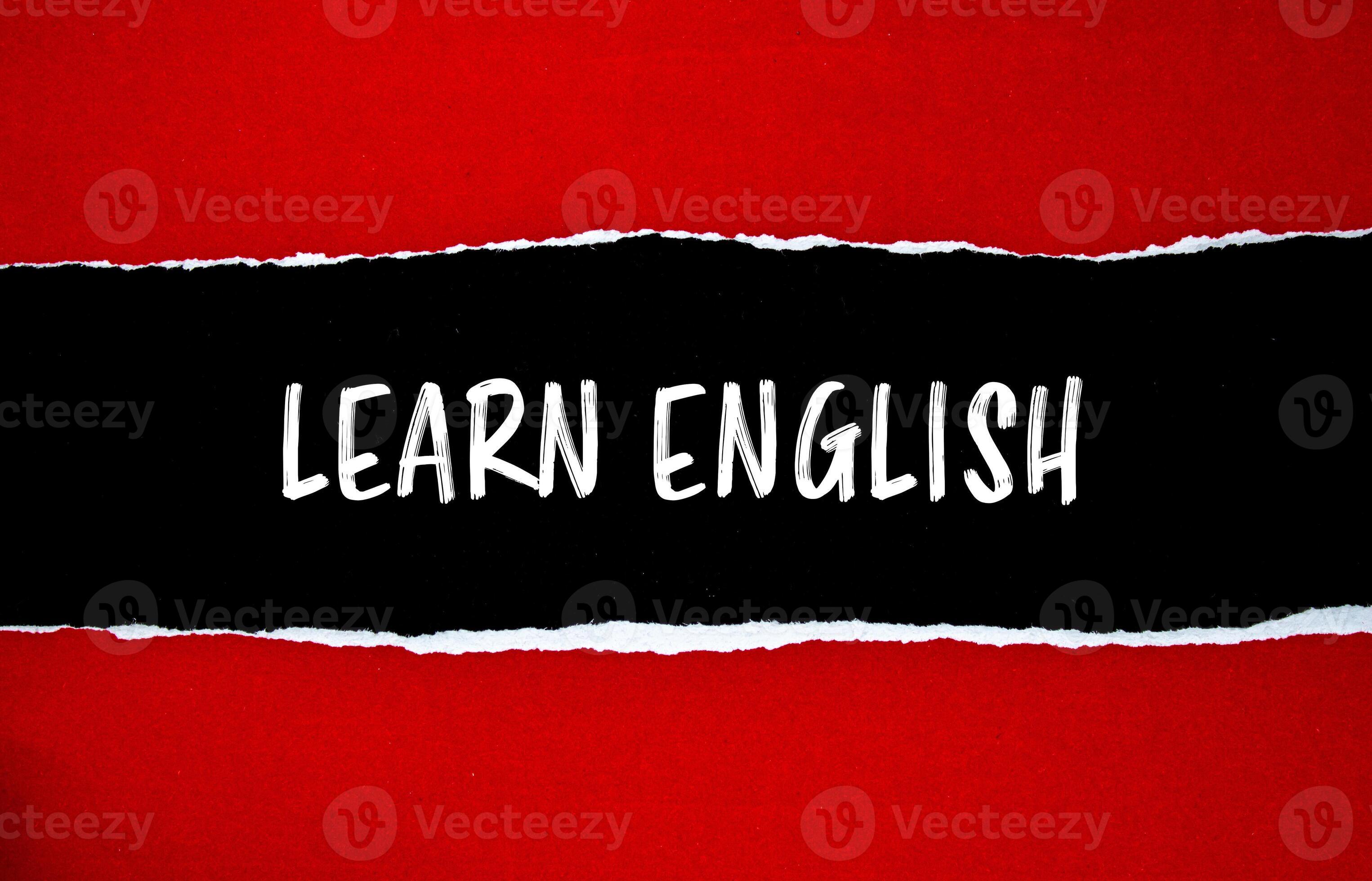 Learn english message written on ripped torn red paper with black background. Conceptual learn ...