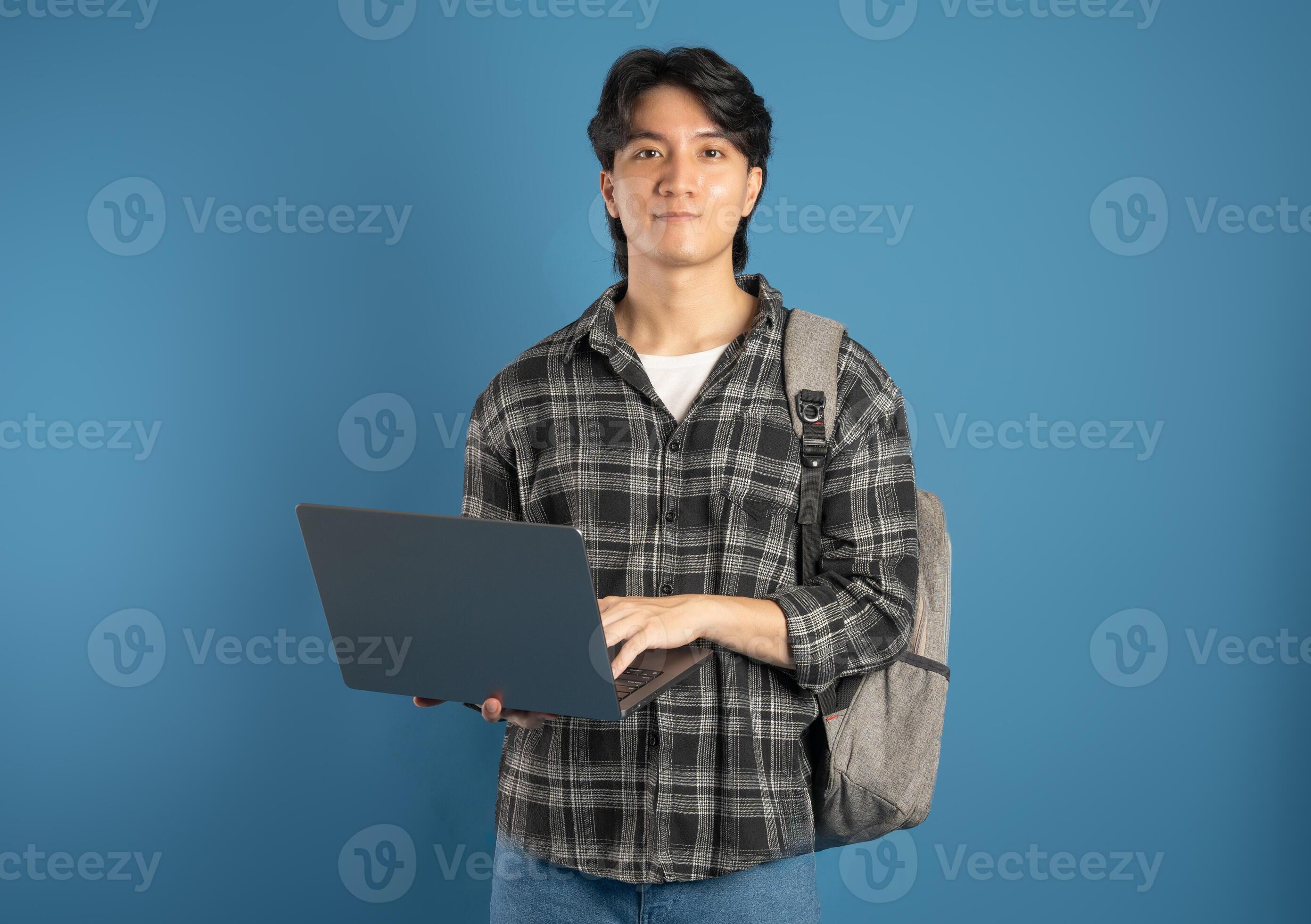Portrait of Asian male student posing on blue background 51216597 Stock ...