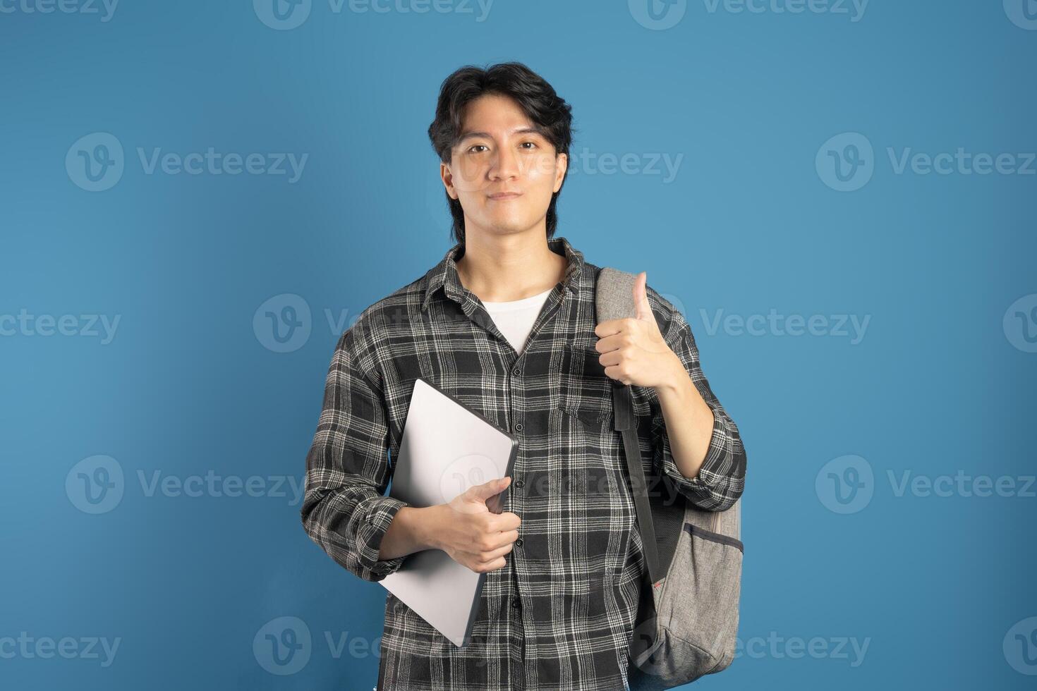 Portrait of Asian male student posing on blue background 51216676 Stock ...