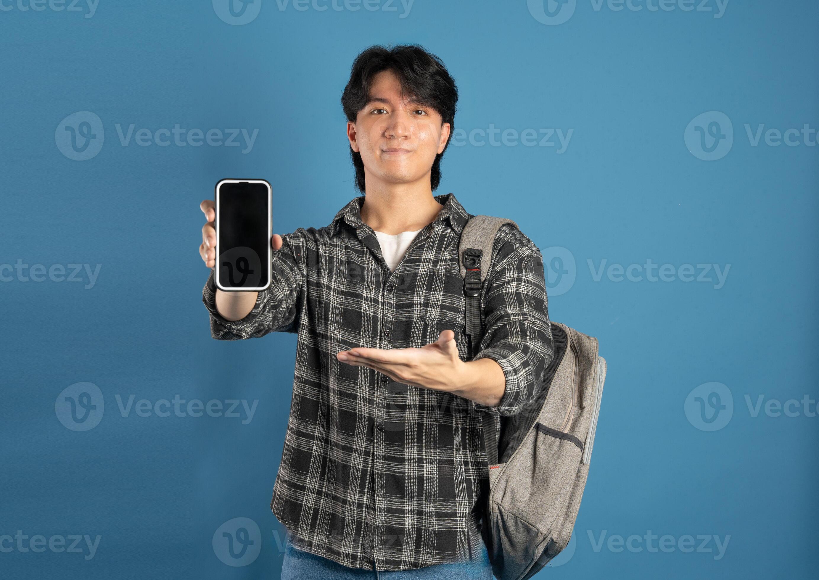 Portrait of Asian male student posing on blue background 51216691 Stock ...