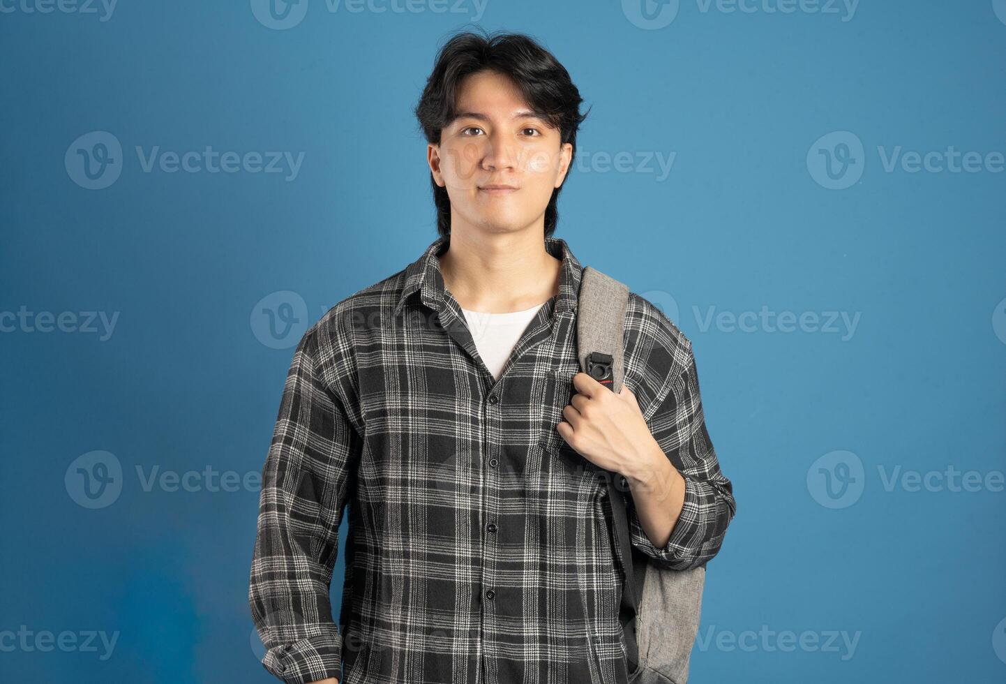 Portrait of Asian male student posing on blue background 51216699 Stock ...