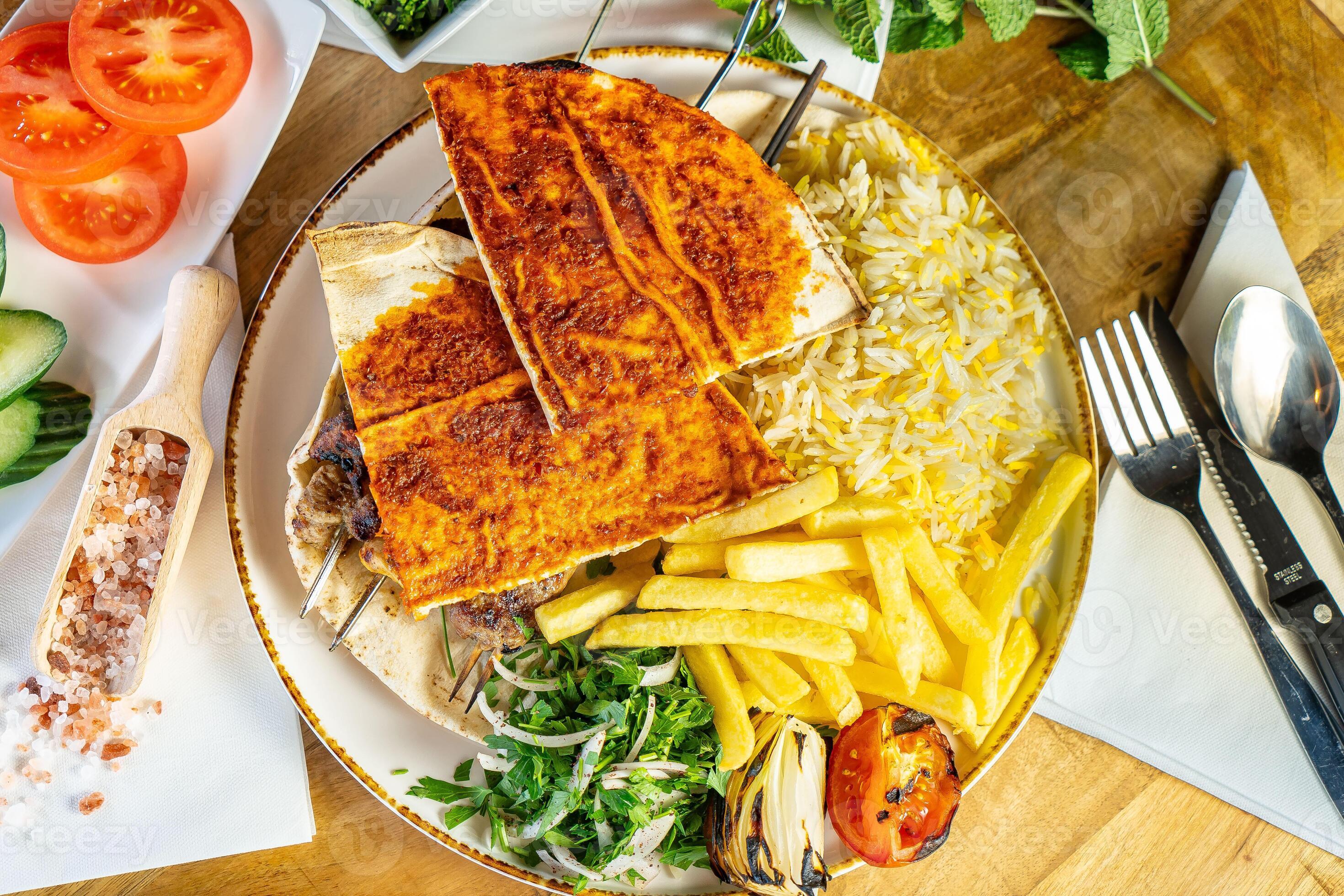 Close up of Middle Eastern Arab meal with fried potato, falafel, hummus ...