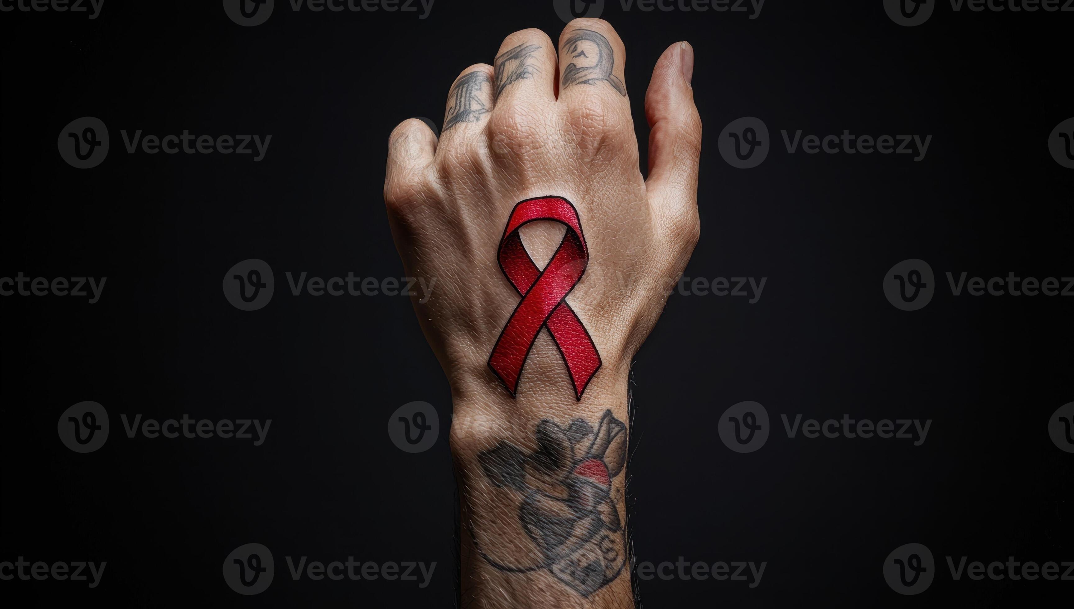 Hand with a red ribbon tattoo, symbolizing HIV and AIDS awareness and support for those affected ...