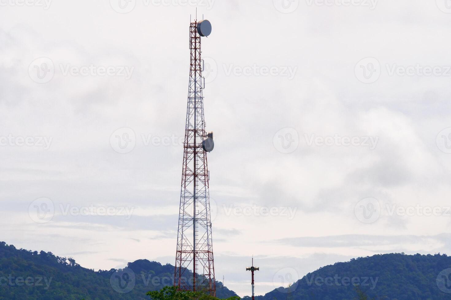 Tall Communication Tower Against Cloudy Sky with Mountainous Background in Rural Area 51666477 ...