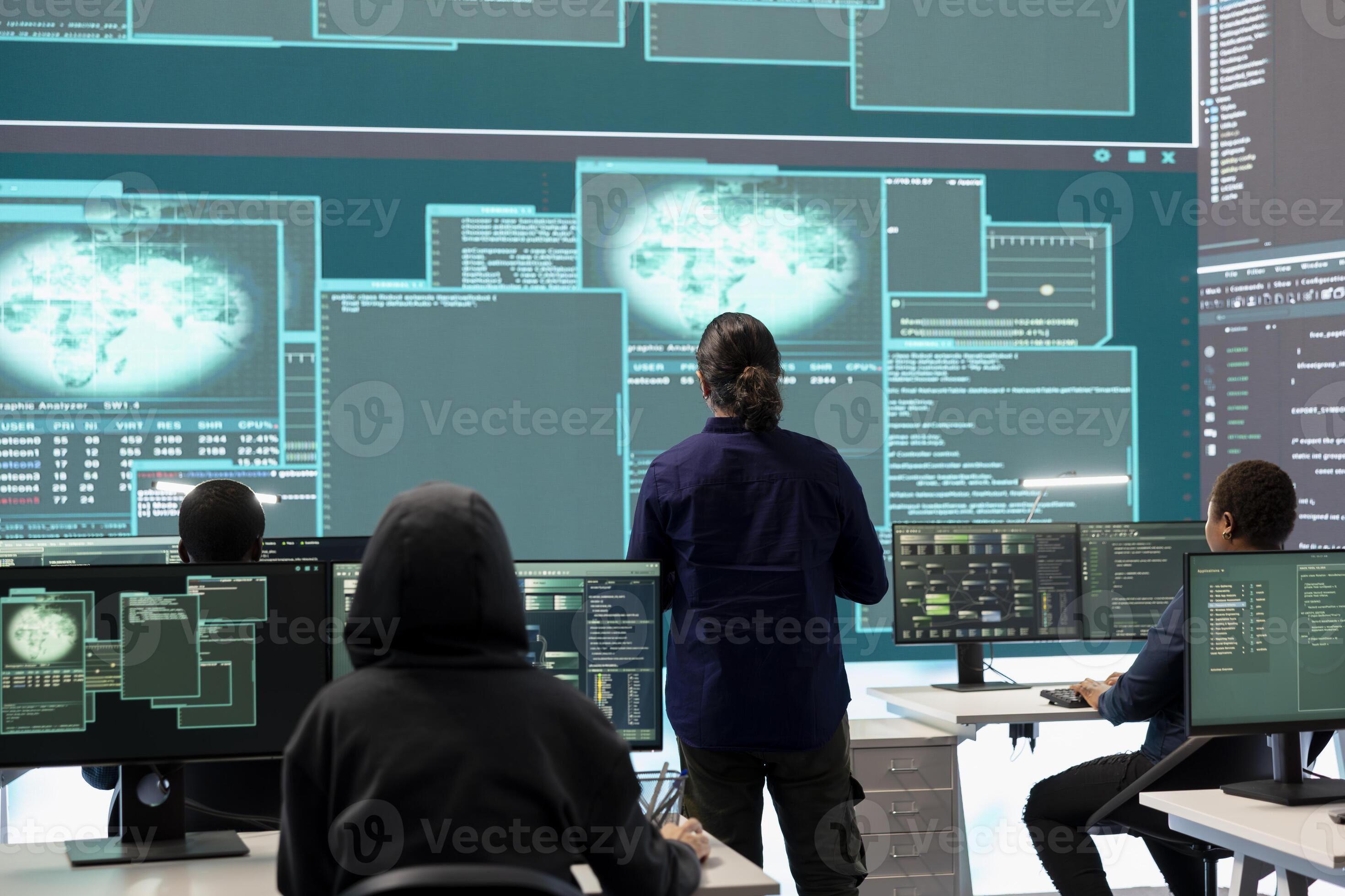 Governmental hacker examines info on a big screen in agency office, using advanced technology to ...