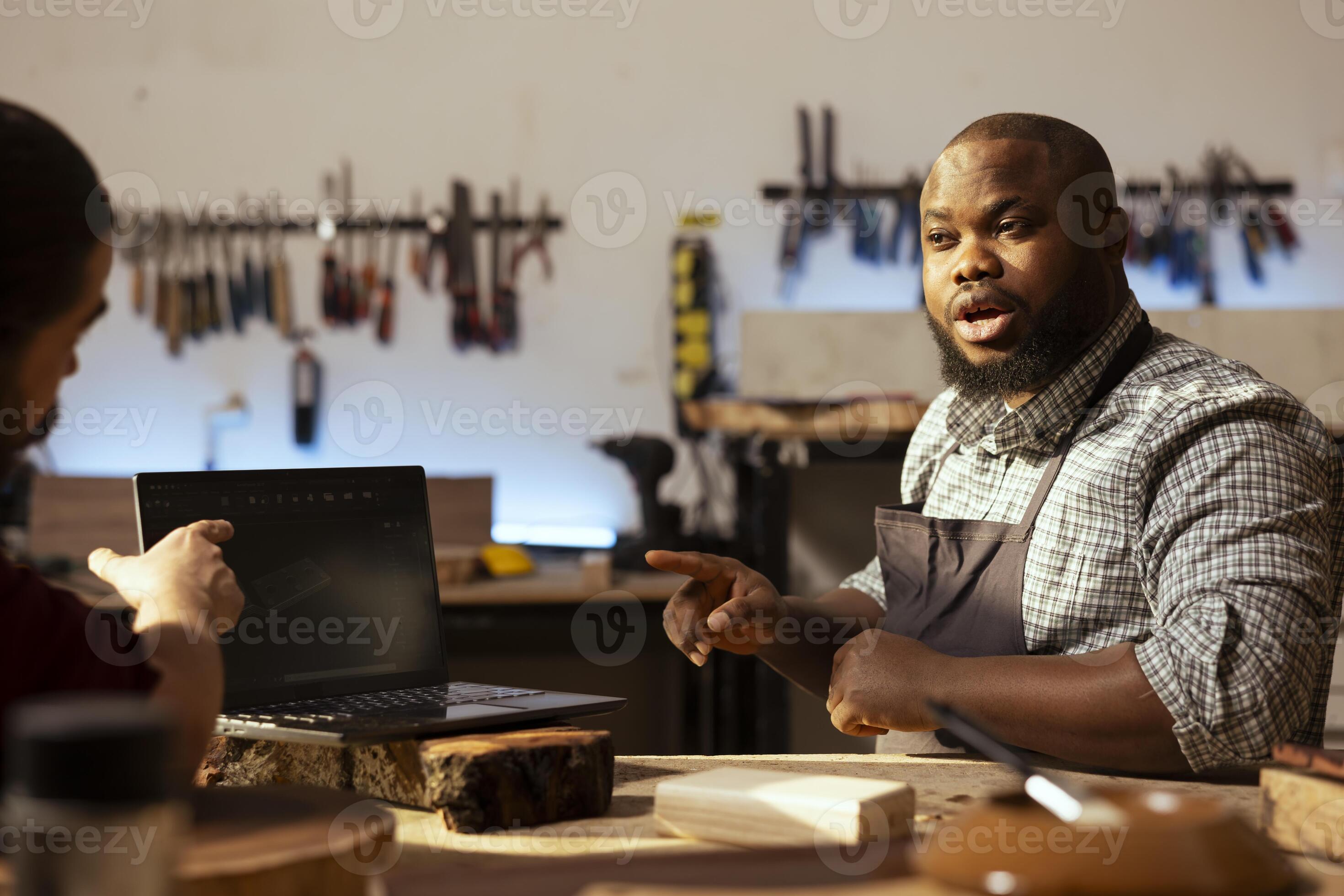 Carpenter in woodworking shop arguing with BIPOC client about commissioned furniture assembling ...