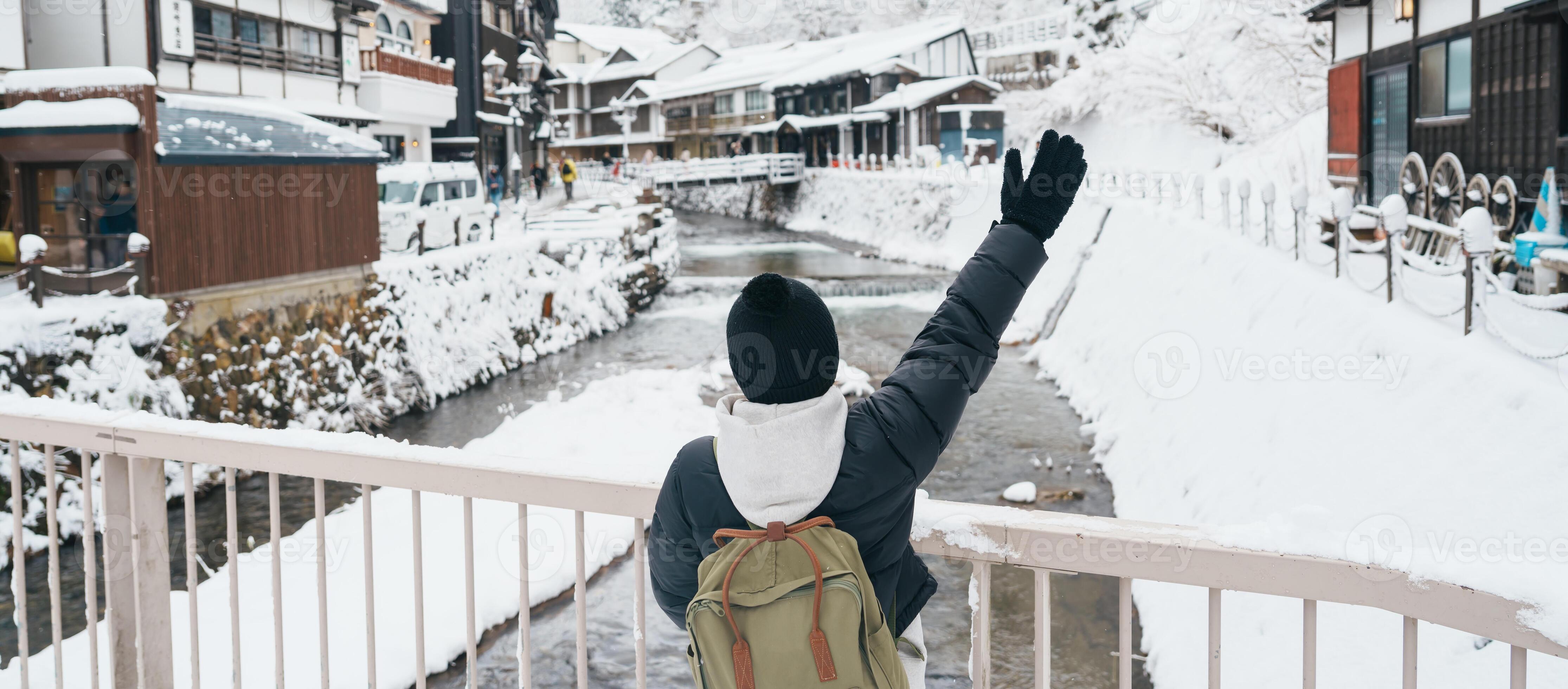 Woman tourist Visiting Ginzan Onsen in Yamagata, happy Traveler sightseeing Japanese Onsen ...