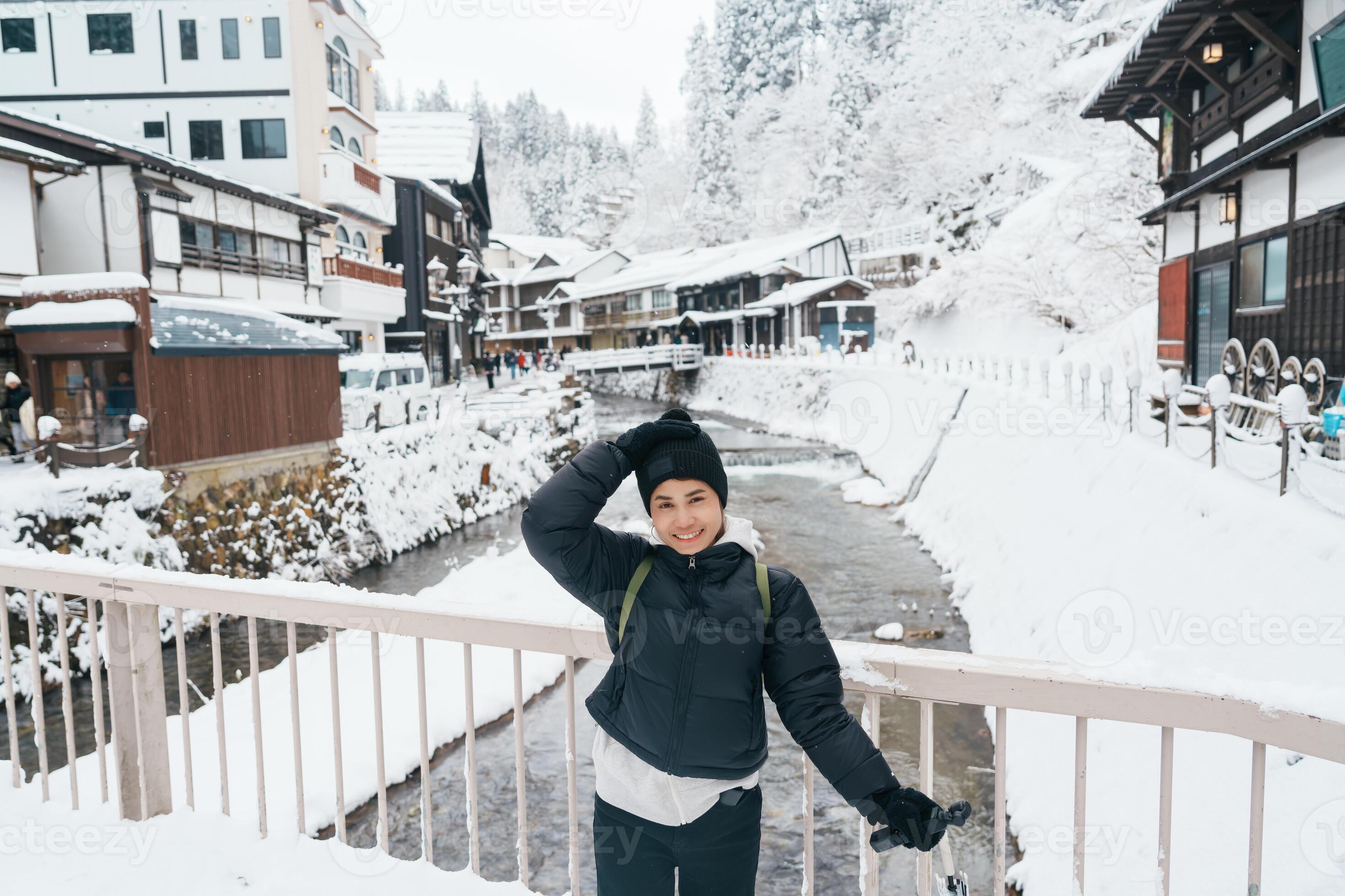 Woman tourist Visiting Ginzan Onsen in Yamagata, happy Traveler sightseeing Japanese Onsen ...