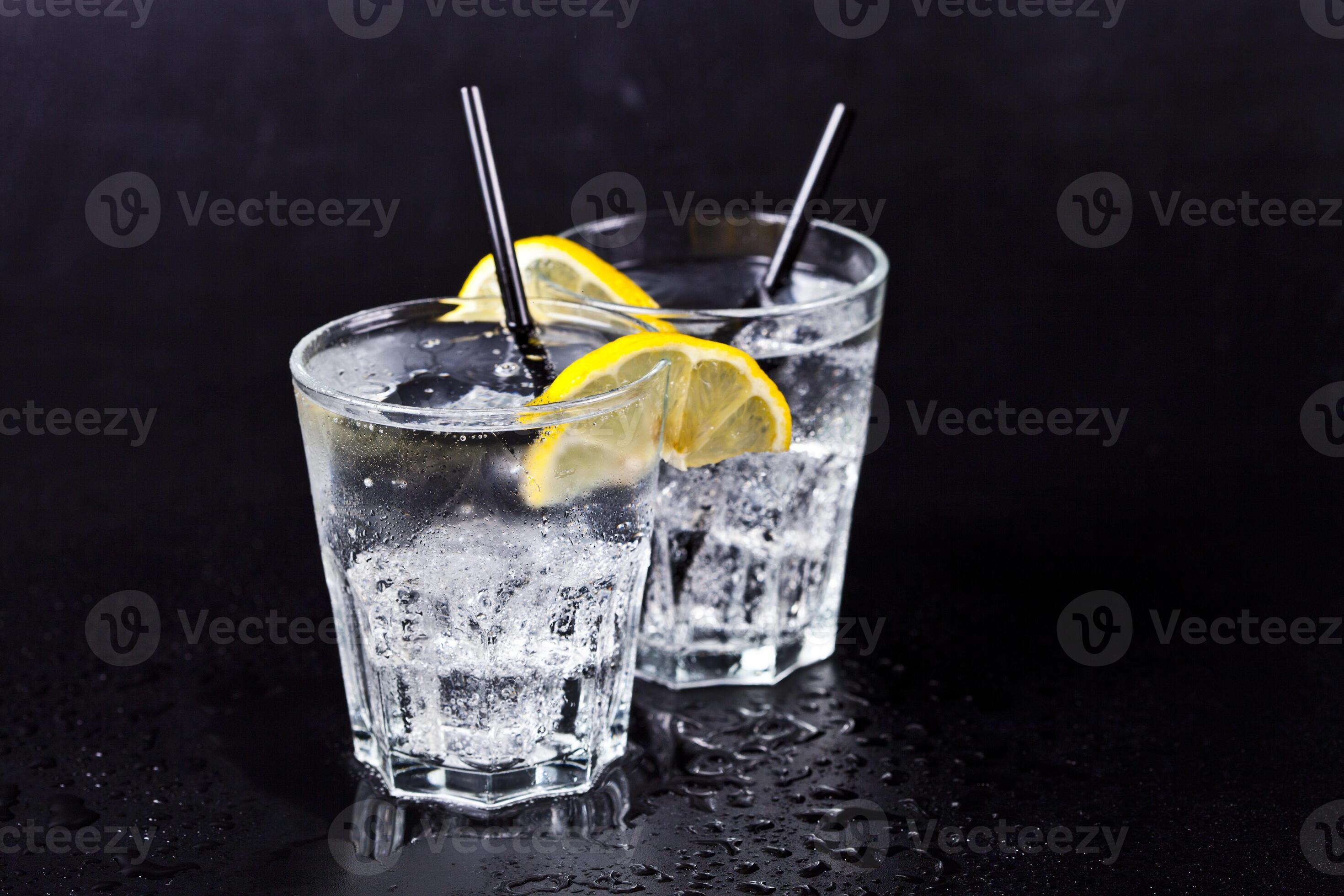 Two glasses of fresh cold carbonated water with ice cubes and lemon slices. 52039278 Stock Photo ...