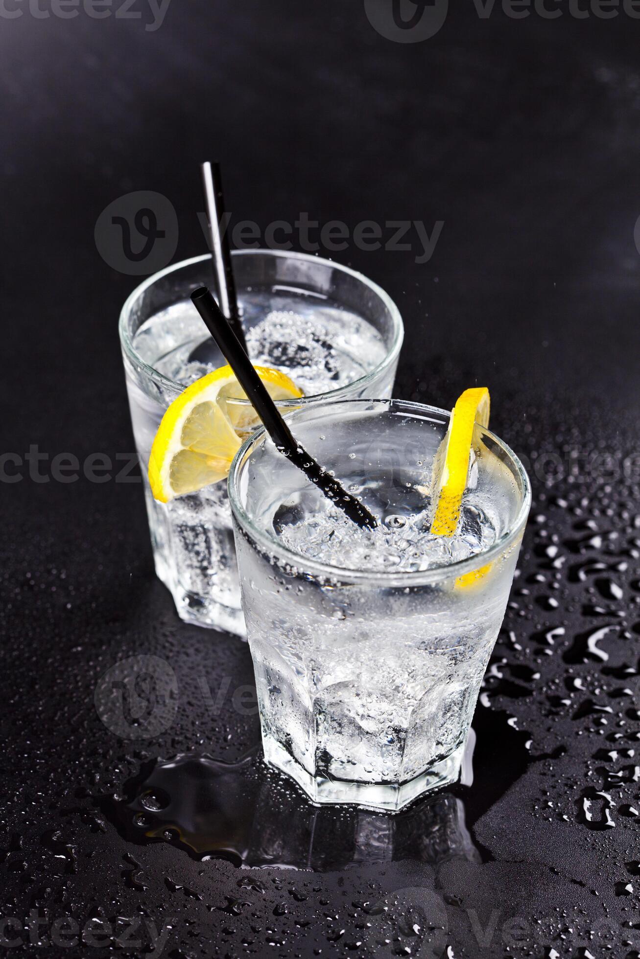 Two glasses of fresh cold carbonated water with ice cubes and lemon slices. 52039280 Stock Photo ...