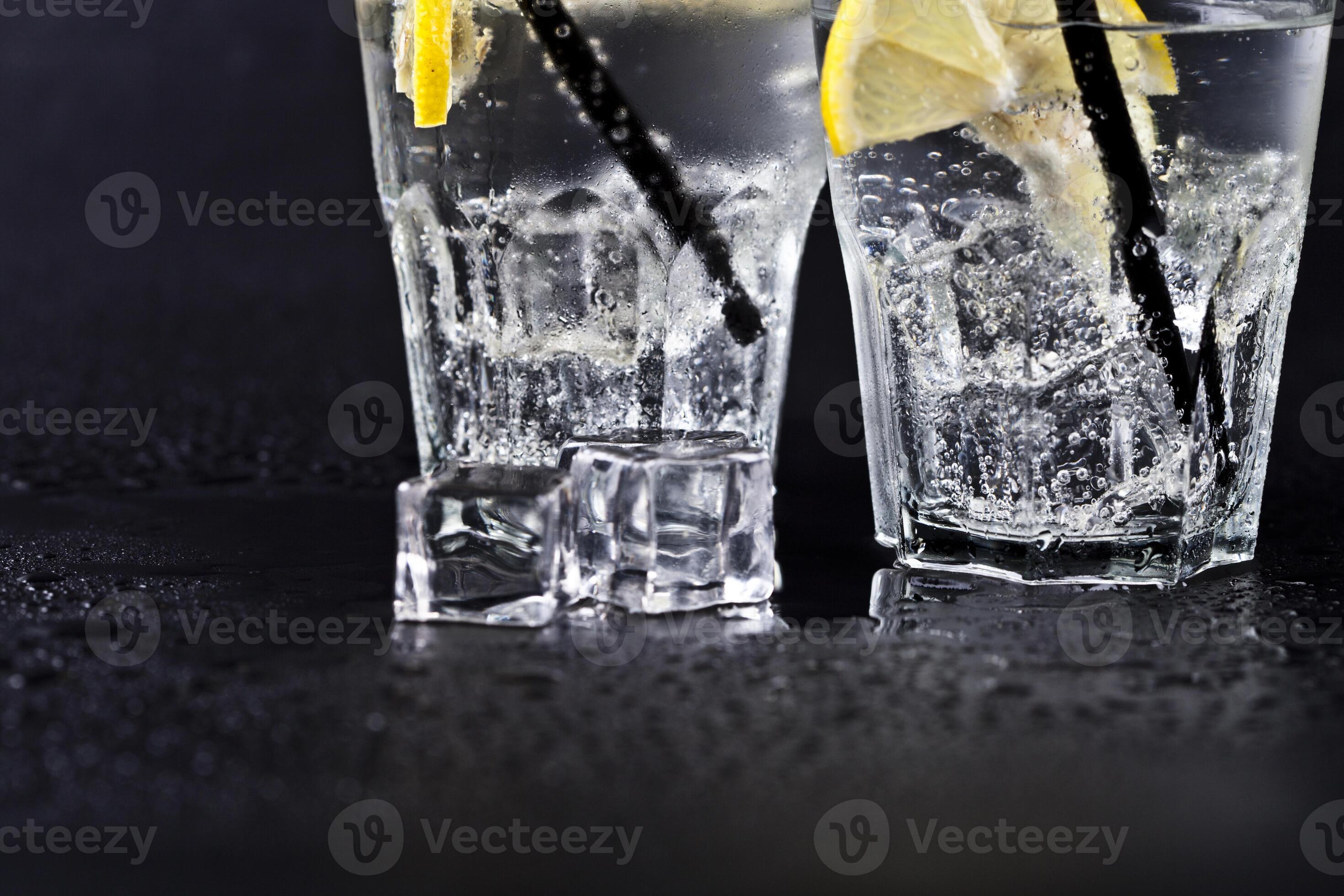 Glasses of fresh cold carbonated water with ice cubes and lemon slices closeup. 52039311 Stock ...